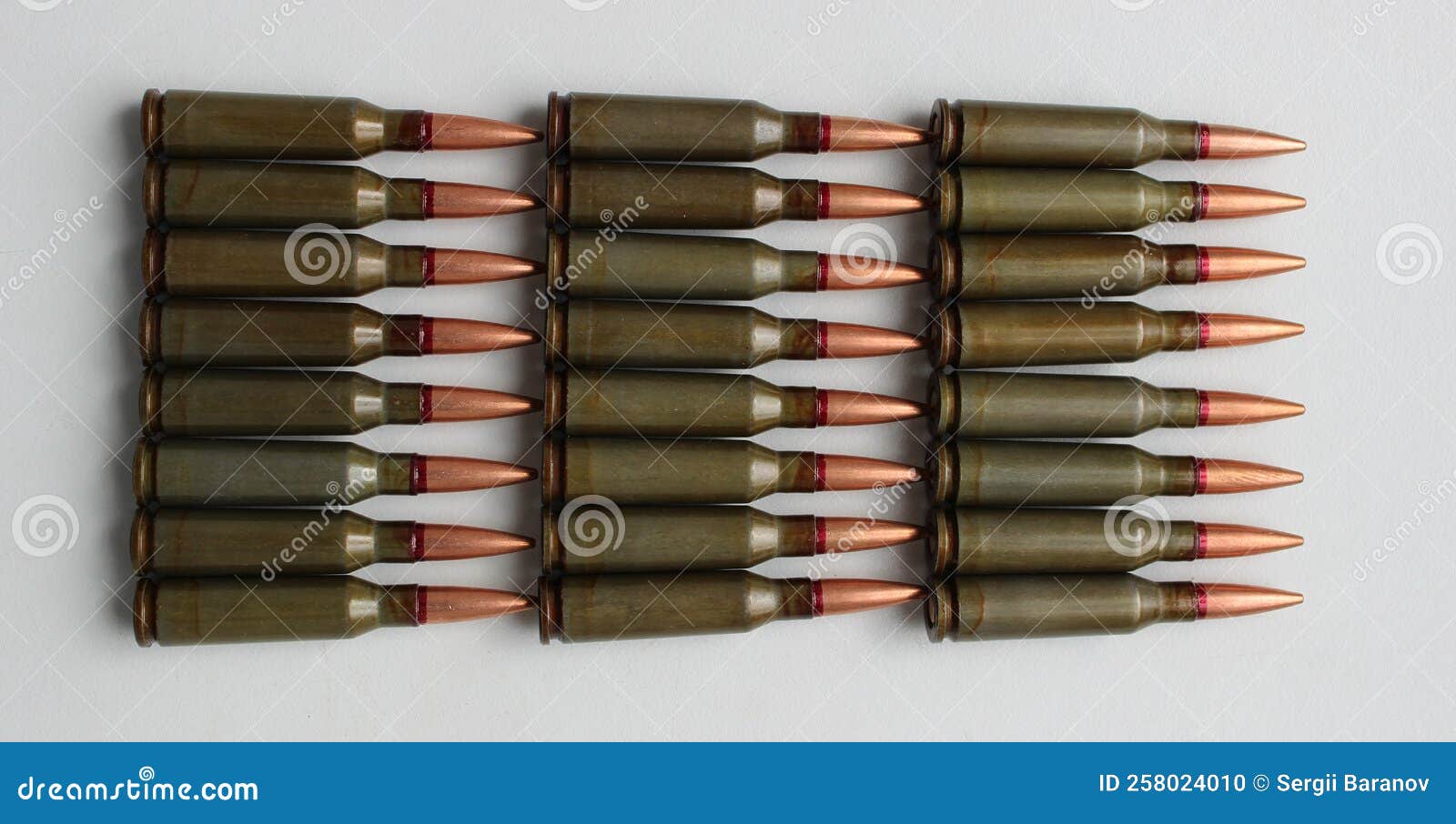 Live Ammunition Caliber 5.45 Laid Out Six in a Rows on a White Surface ...