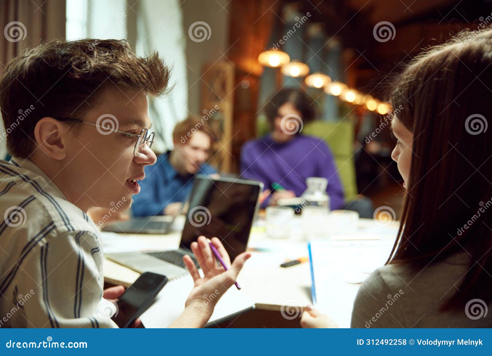 Lively Discussion. Students Gathering Together in Library and Studying ...