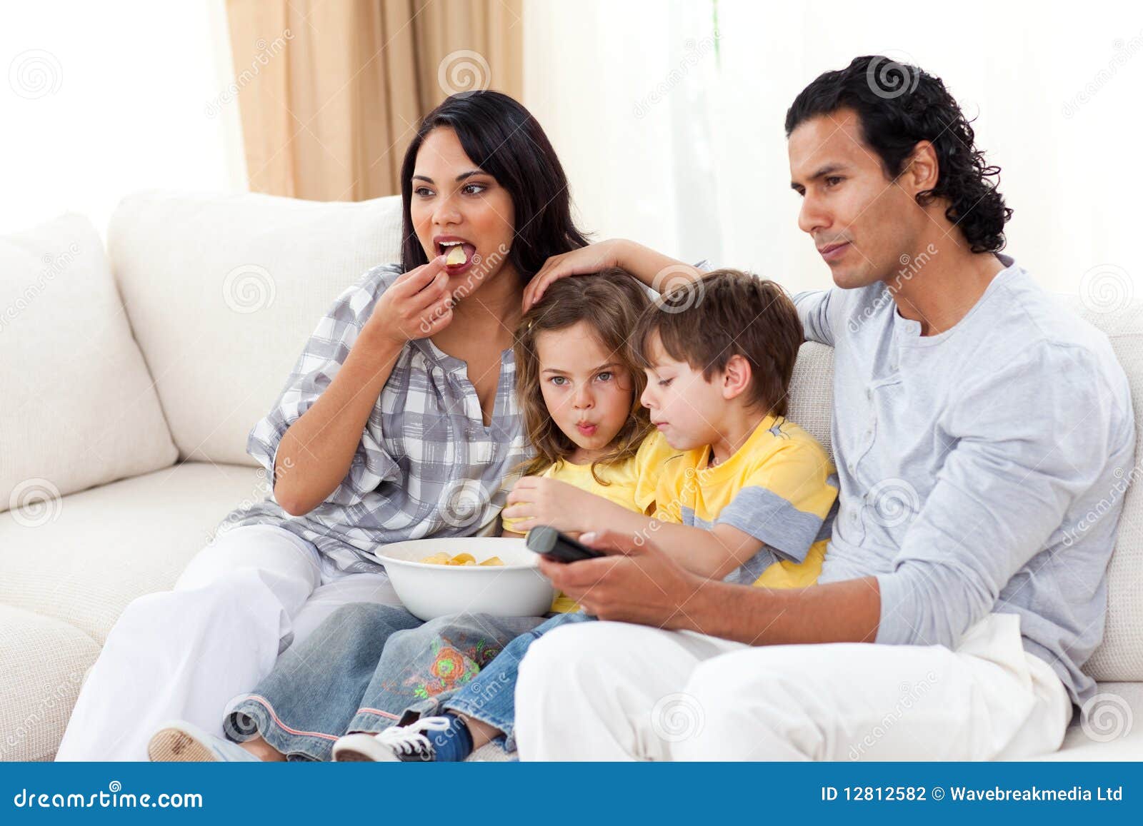 Lively Family Watching TV and Eating Chips Stock Photo - Image of ...
