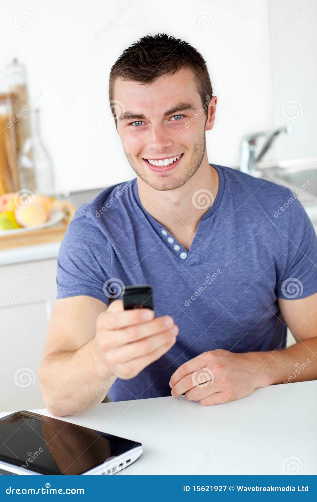 Lively Young Man Sending a Text and Smiling Stock Image - Image of ...