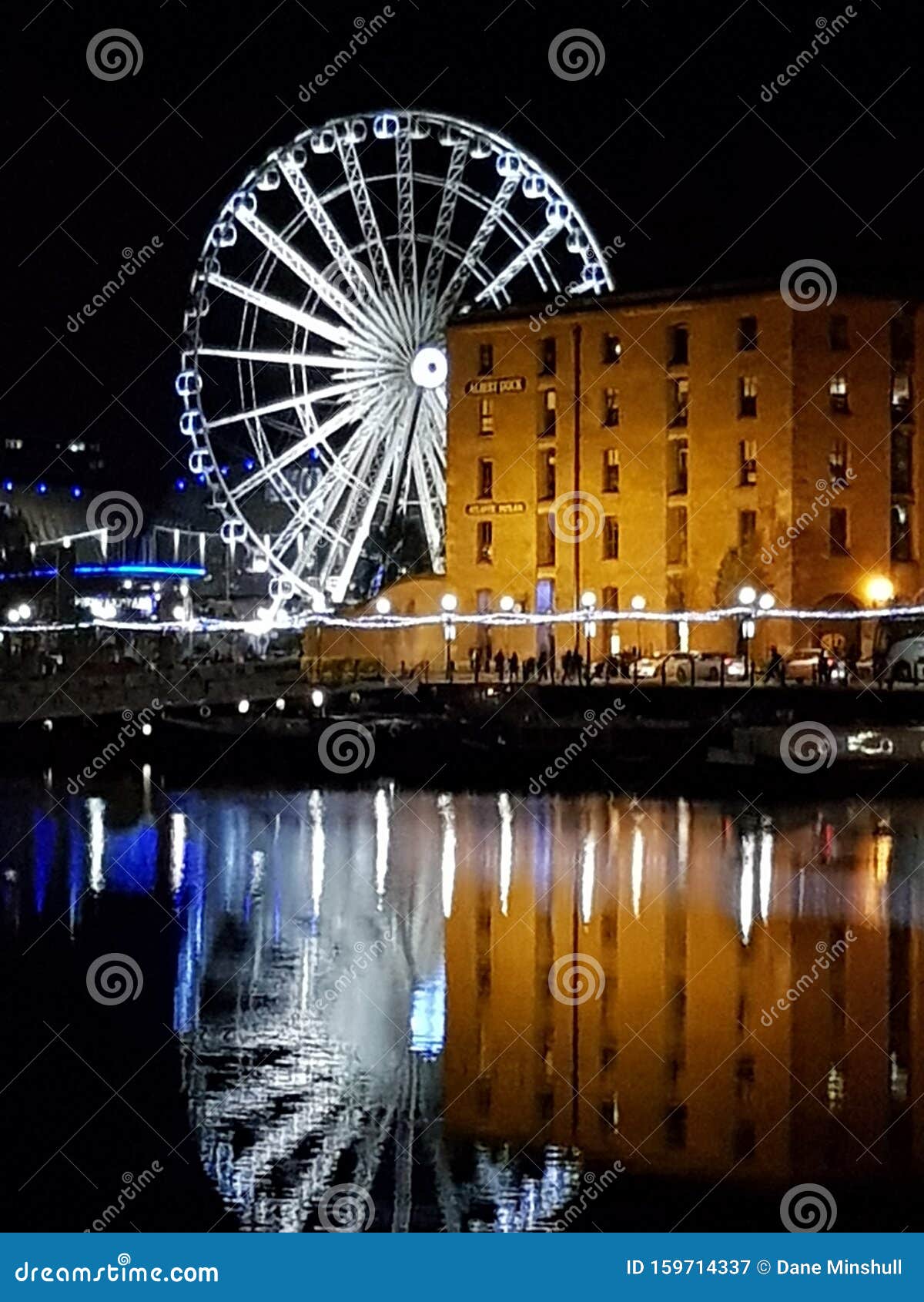 Liverpool Docks at Night with a Big Wheel Reflected in the River Stock ...