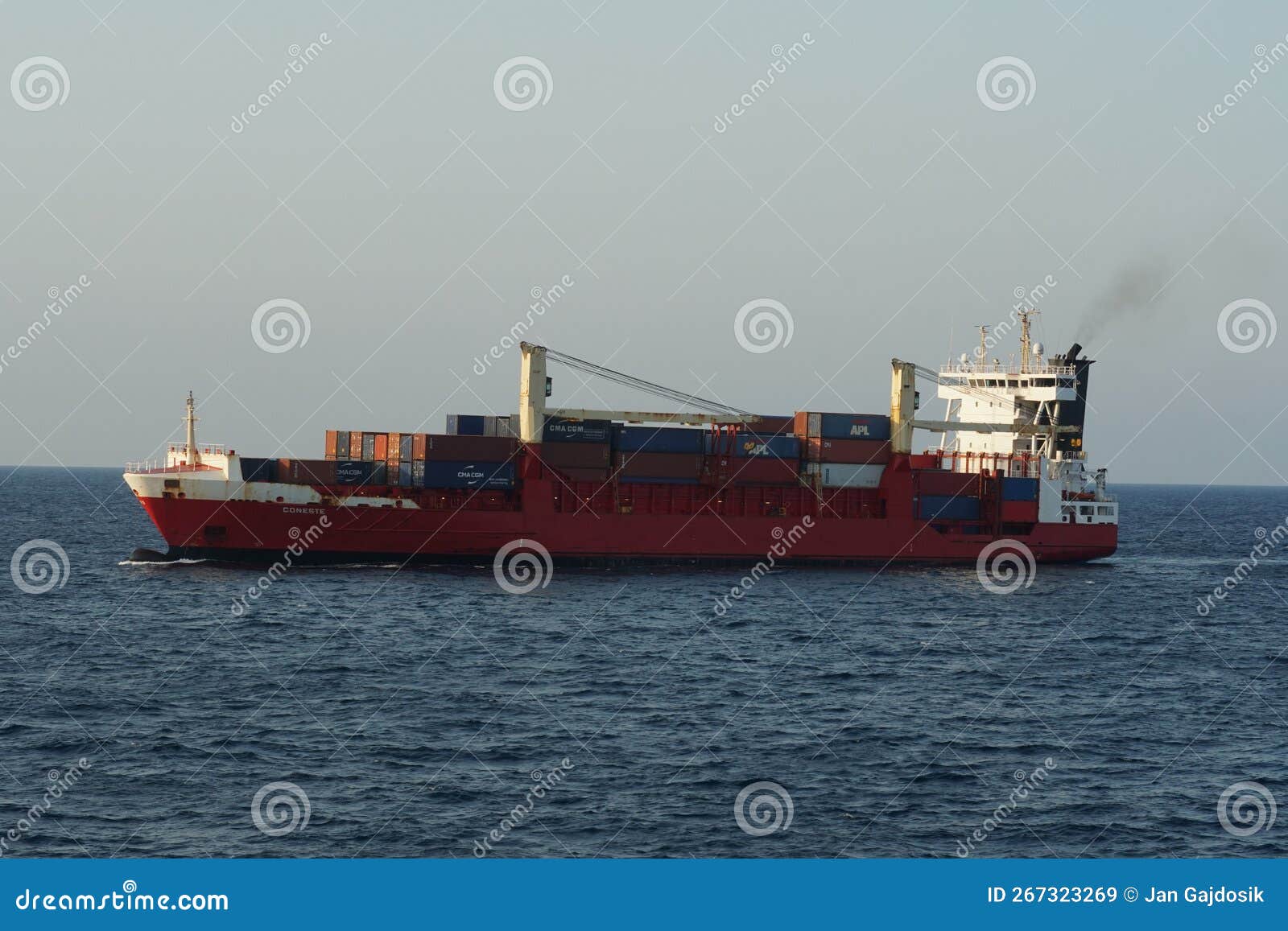 Loaded Container Vessel with Red Hull and Equipped with Two Cargo ...