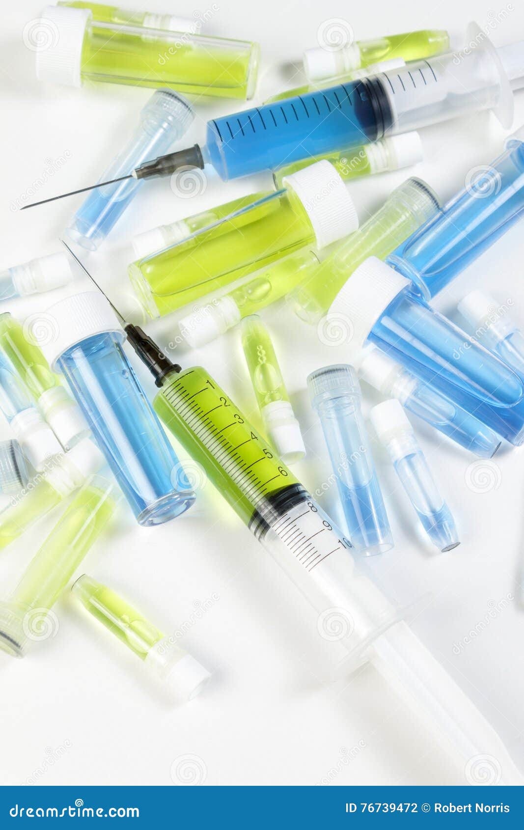 Loaded Syringe S and Vials Containing Blue and Green Fluids Stock Photo ...
