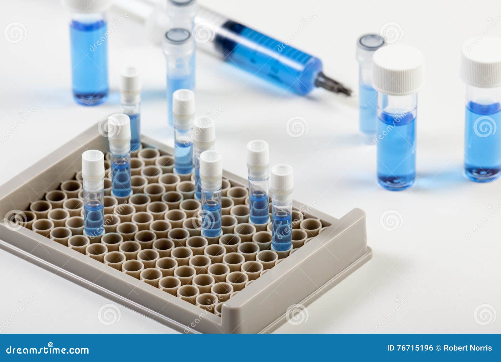 Loaded Vial Rack Containing Blue Fluid and Syringe Stock Photo - Image ...