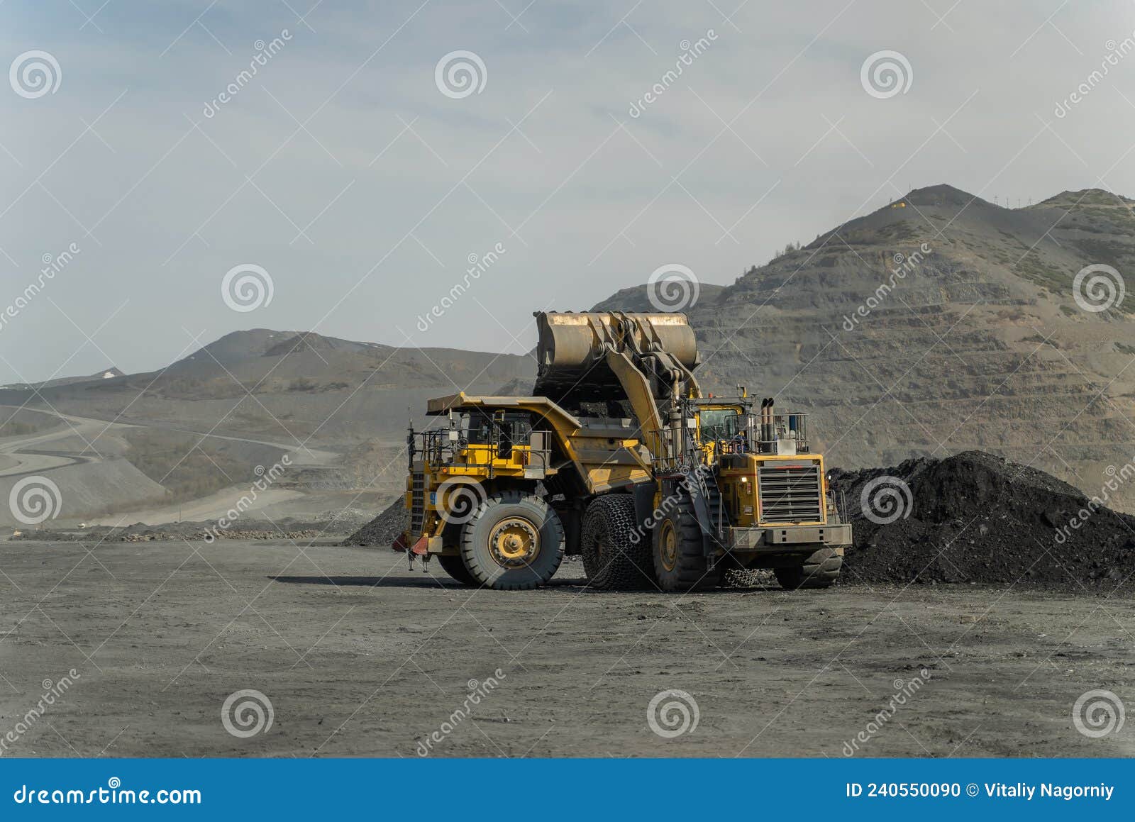 A Loader Loads Ore into a Dump Truck. Stock Photo - Image of truck ...
