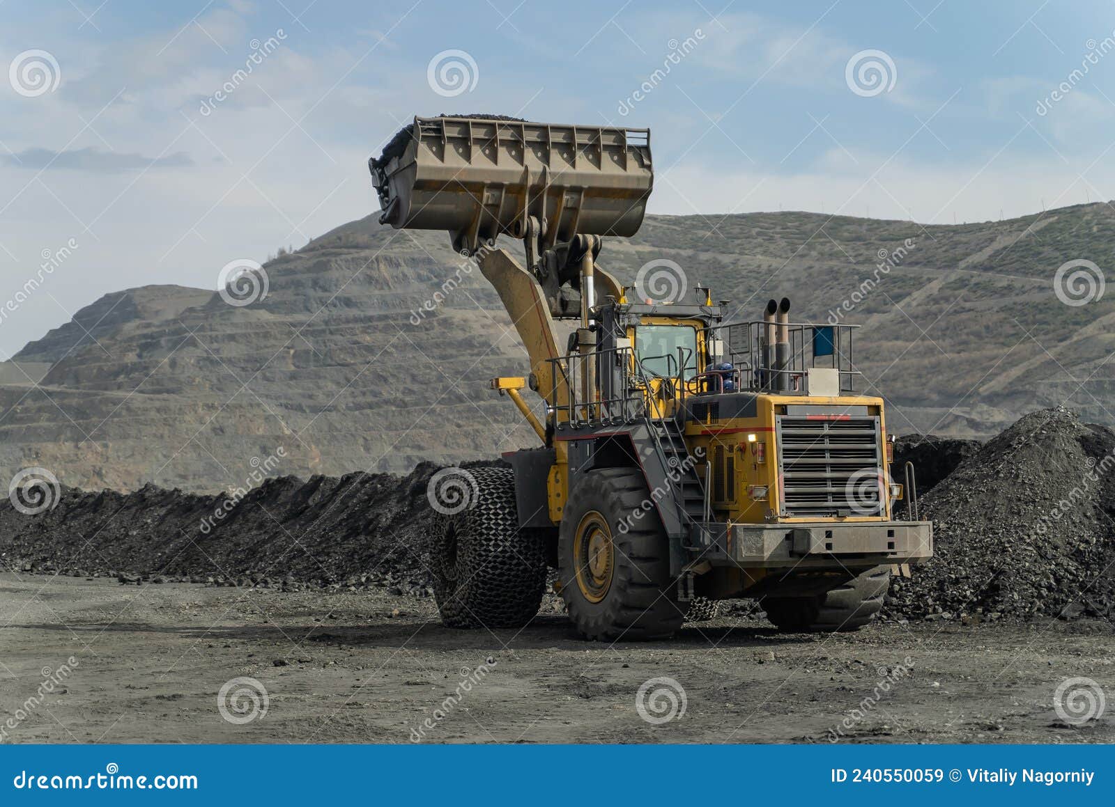 The Loader Stands with the Bucket Lifted in the Open Pit. Stock Image ...
