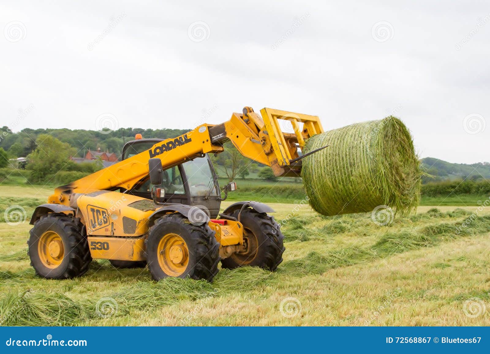 Loader Tractor Moving a Round Bale from Field Editorial Photography ...