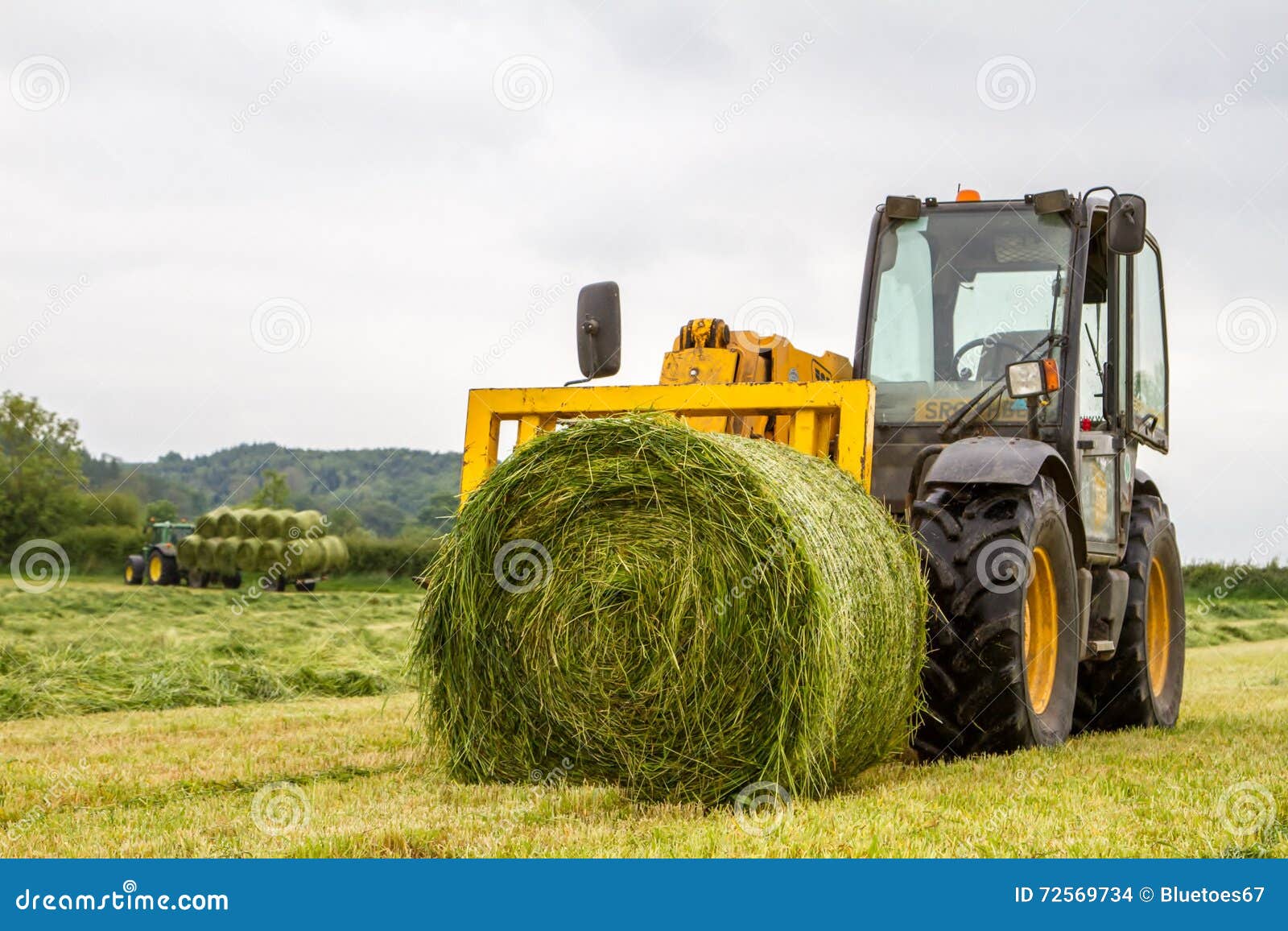 Loader Tractor Moving a Round Bale from Field Editorial Stock Image ...