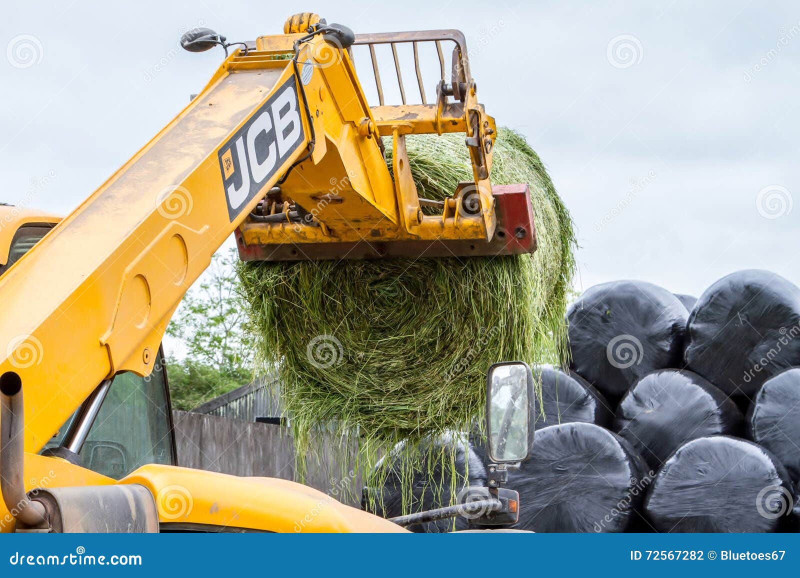 Loader Tractor Stacking Round Bales in a Stack Editorial Photography ...