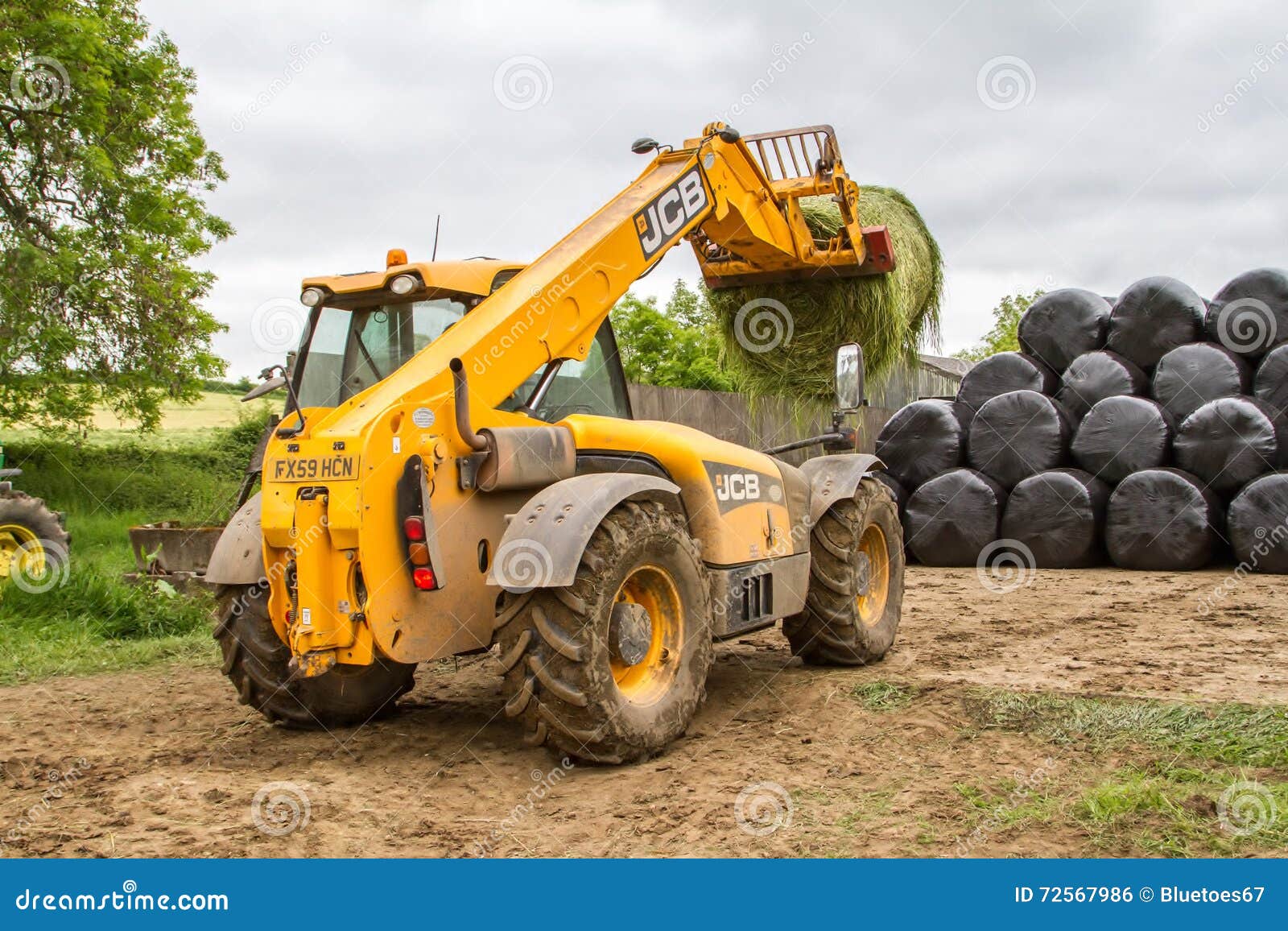 Loader Tractor Stacking Round Bales in a Stack Editorial Photo - Image ...