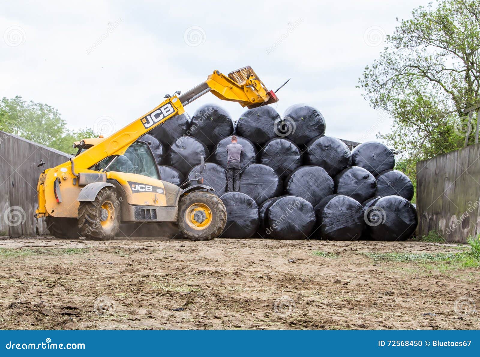 Loader Tractor Stacking Round Bales in a Stack Editorial Image - Image ...