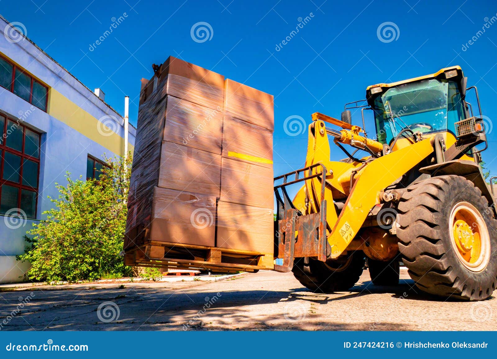 Loader Unloads Pallets with Goods Stock Photo - Image of loading ...