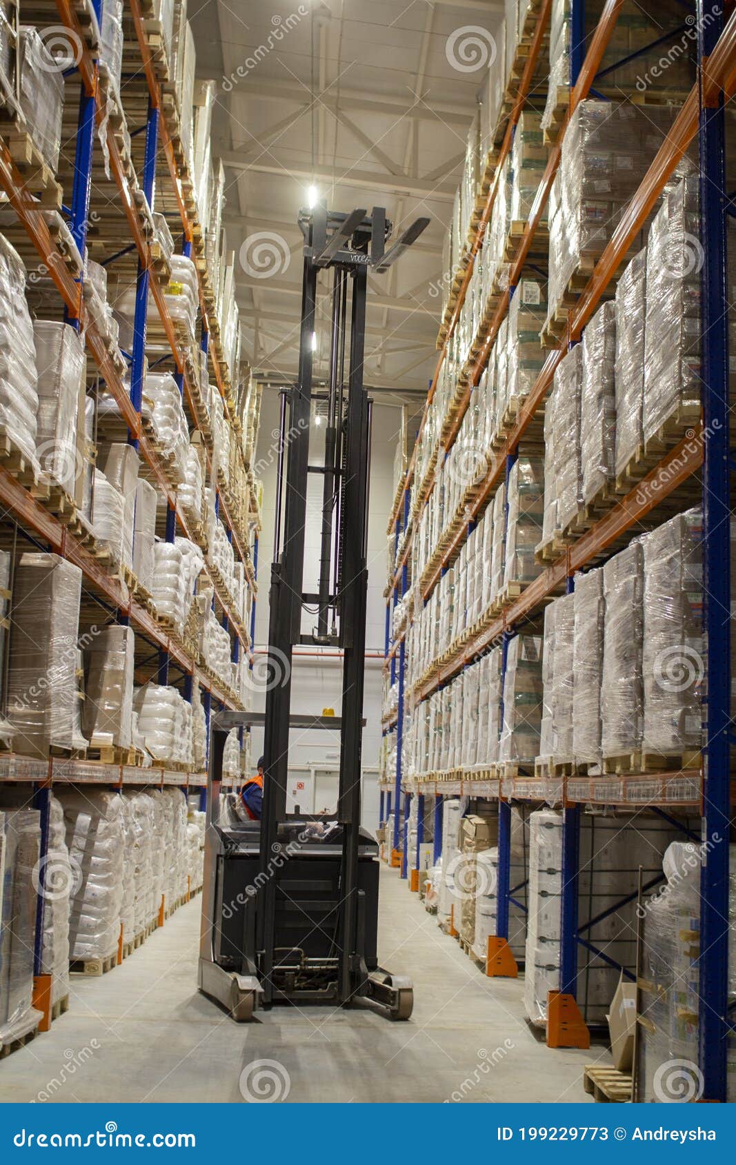 Loader in Warehouses. Stacks of Boxes in an Industrial Warehouse. Stock ...