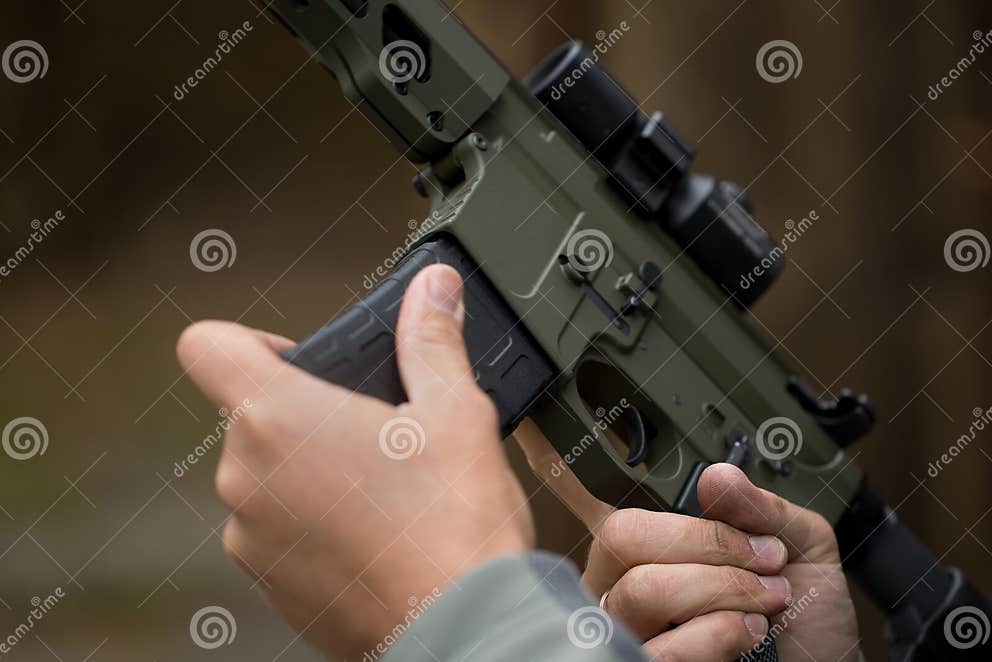 Loading Ammunition into a Clip. Reloading Weapons. Stock Photo - Image ...