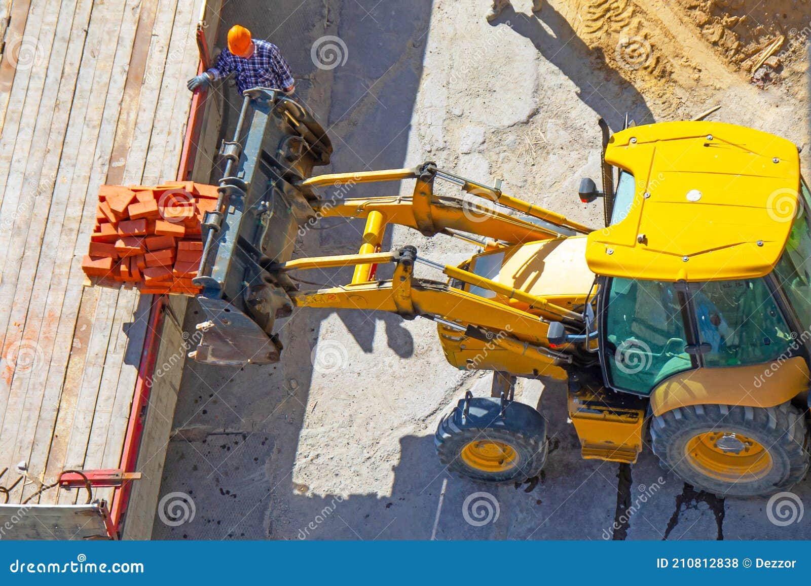 Loading Bricks into the Cargo Body of a Truck Using a Tractor with a ...
