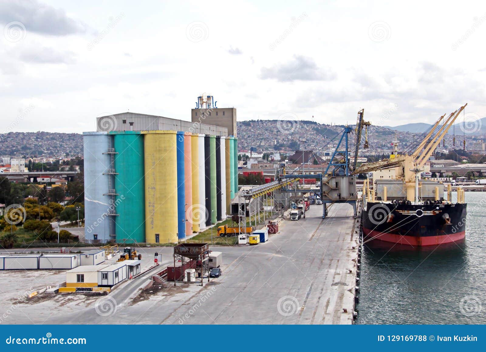 Loading Cargo of Cement Clinker in Bulk Carrier by Ships Cranes in the ...