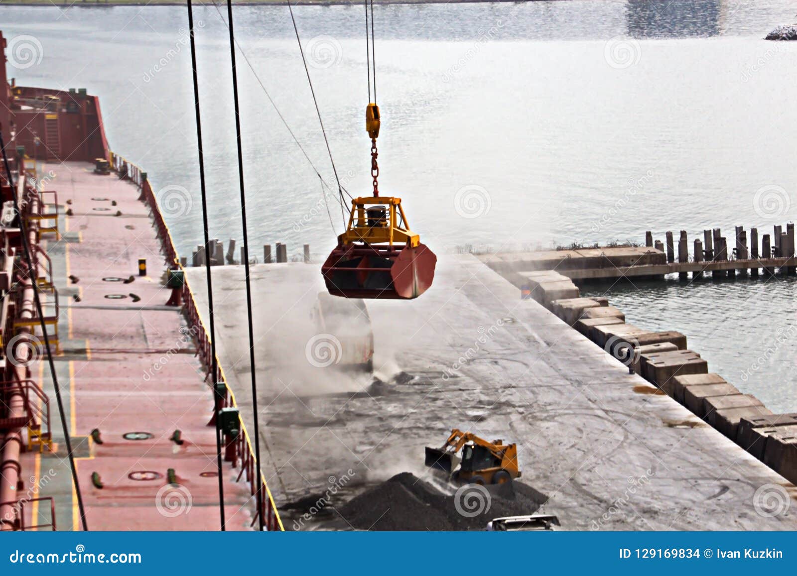Loading Cargo of Cement Clinker in Bulk Carrier by Ships Cranes in the ...