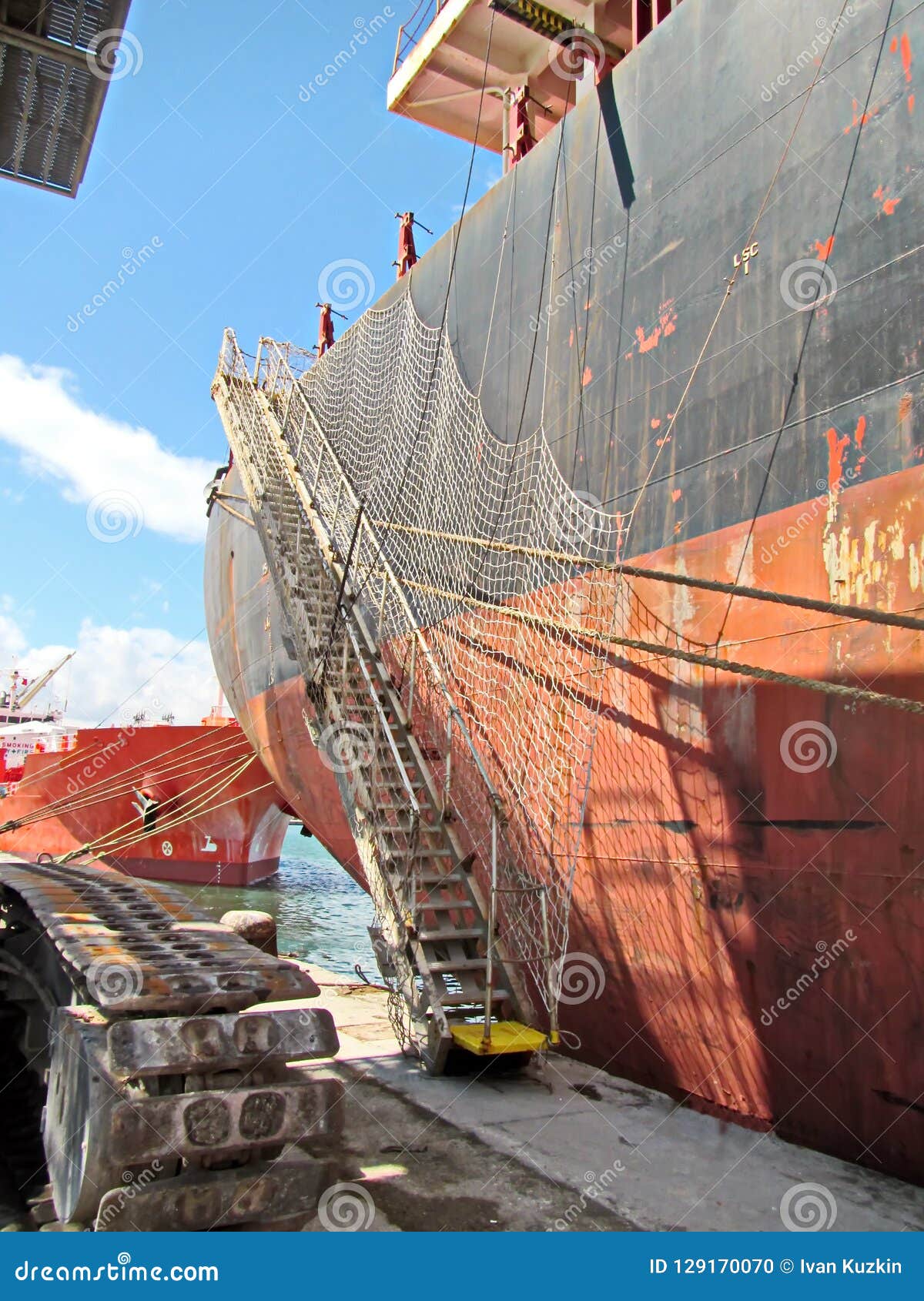 Loading Cargo of Cement Clinker in Bulk Carrier by Ships Cranes in the ...
