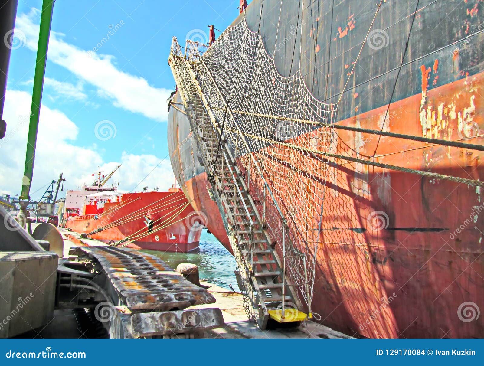 Loading Cargo of Cement Clinker in Bulk Carrier by Ships Cranes in the ...