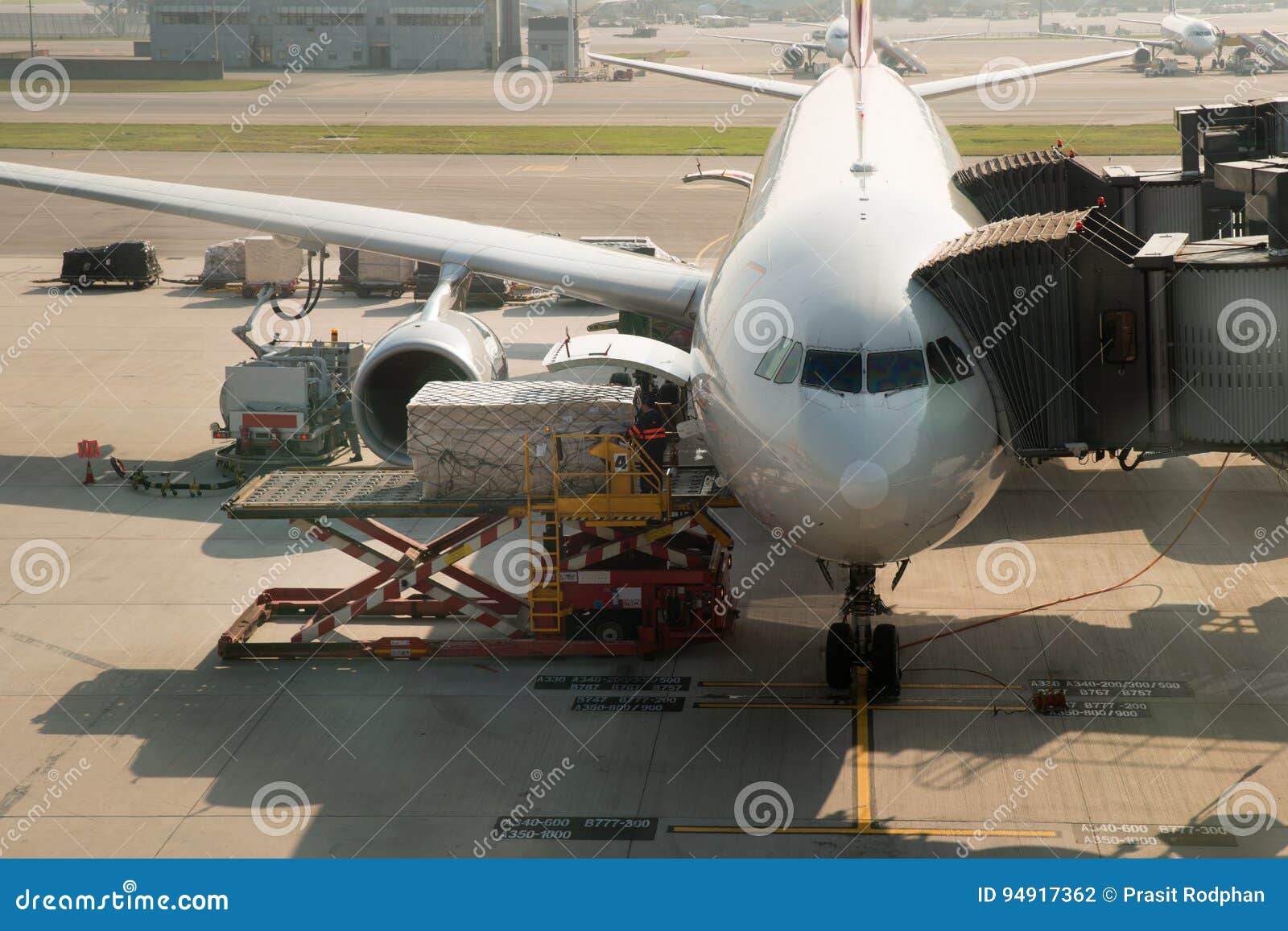 Loading Cargo on Plane in Airport before Flight. Editorial Photography ...