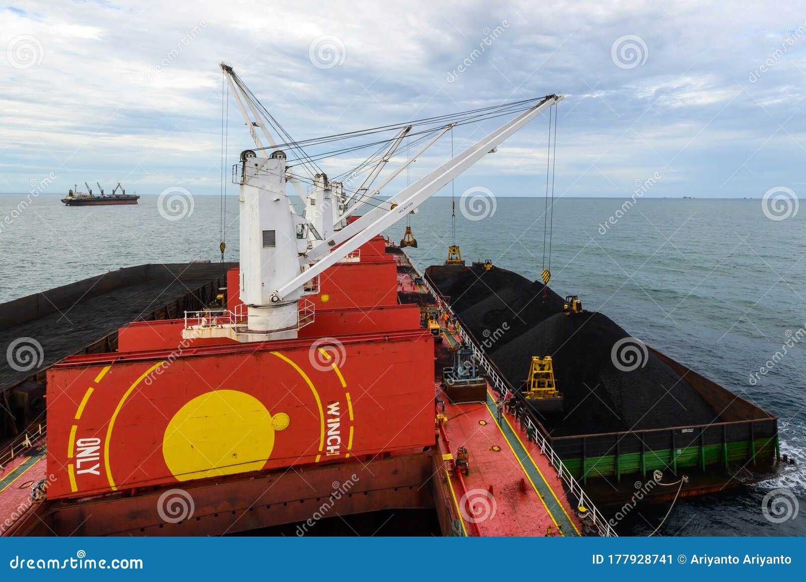 Loading Coal From Cargo Barges Onto A Bulk Vessel Using Ship Cranes In ... Loading Coal From Cargo Barges Onto A Bulk Vessel Using Ship Cranes In ...