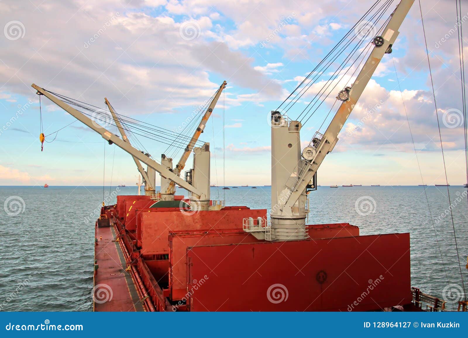 Loading Coal from Cargo Barges Onto a Bulk Carrier Using Ship Cranes ...