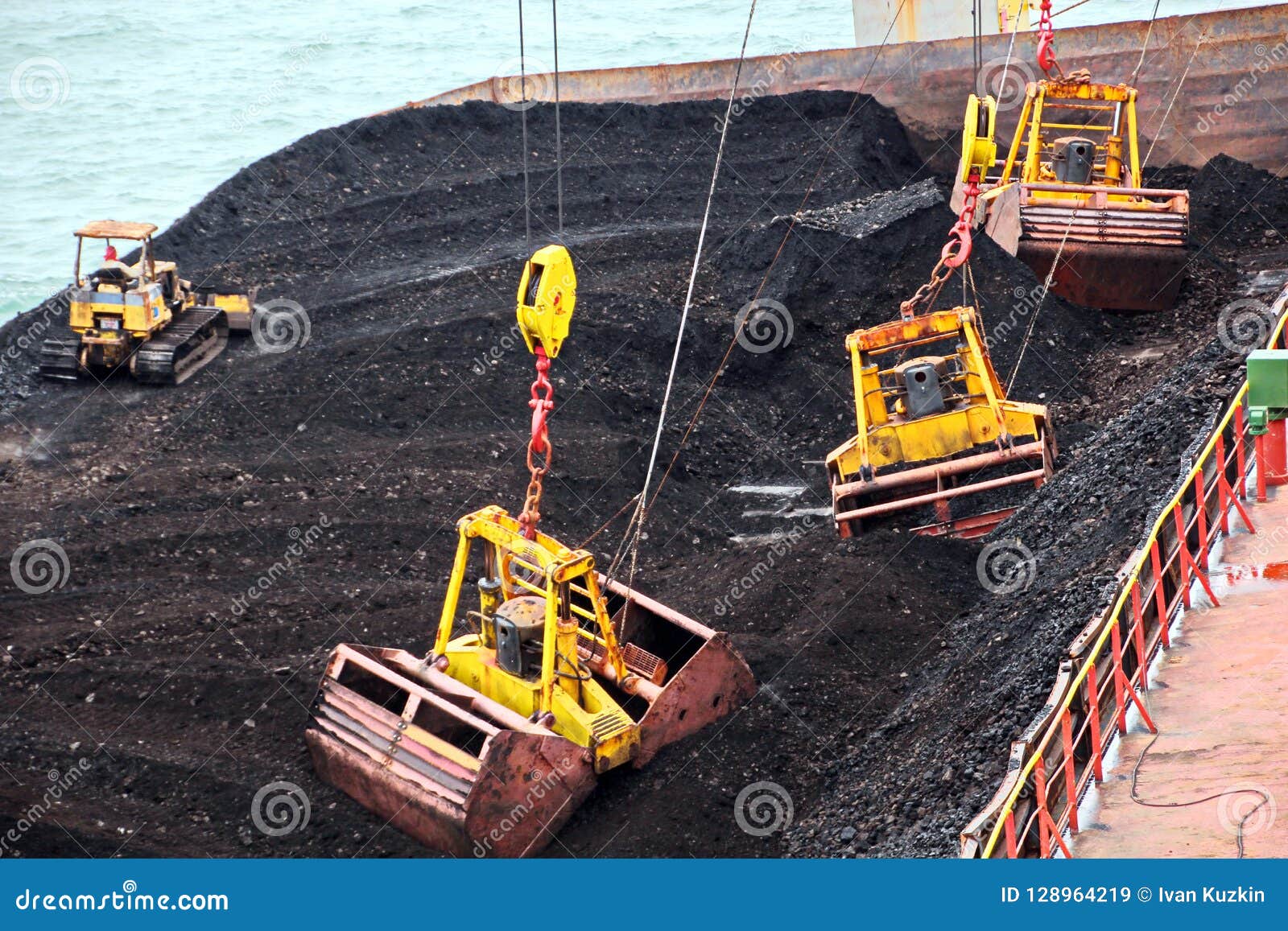 Loading Coal from Cargo Barges Onto a Bulk Carrier Using Ship Cranes ...