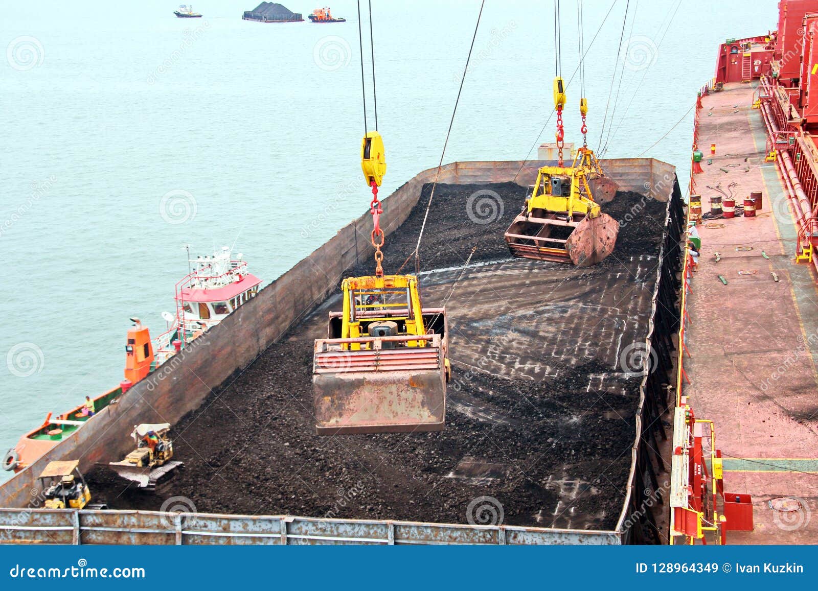 Loading Coal from Cargo Barges Onto a Bulk Carrier Using Ship Cranes ...