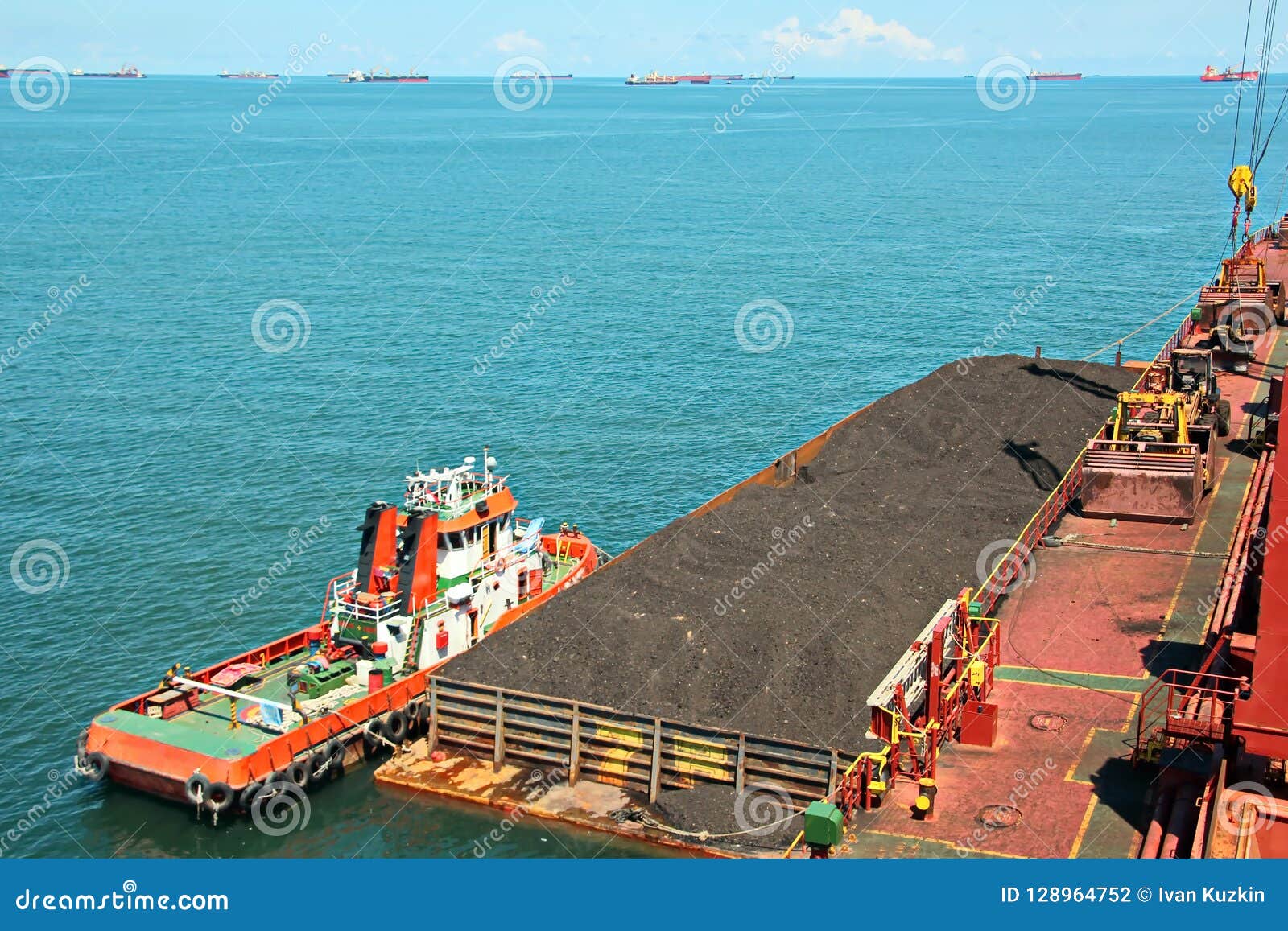Loading Coal from Cargo Barges Onto a Bulk Carrier Using Ship Cranes ...