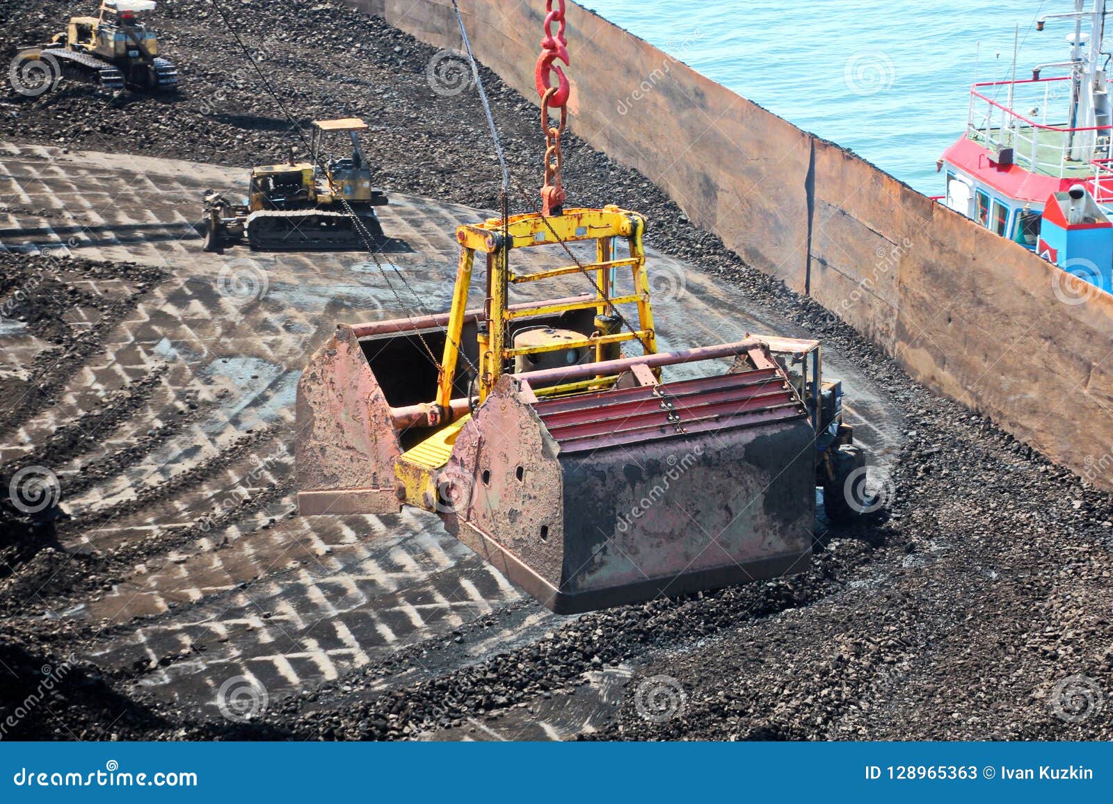 Loading Coal from Cargo Barges Onto a Bulk Carrier Using Ship Cranes ...