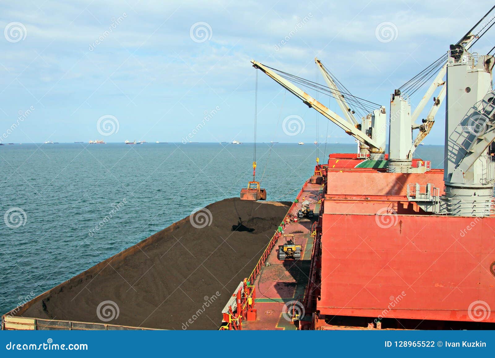 Loading Coal from Cargo Barges Onto a Bulk Carrier Using Ship Cranes ...