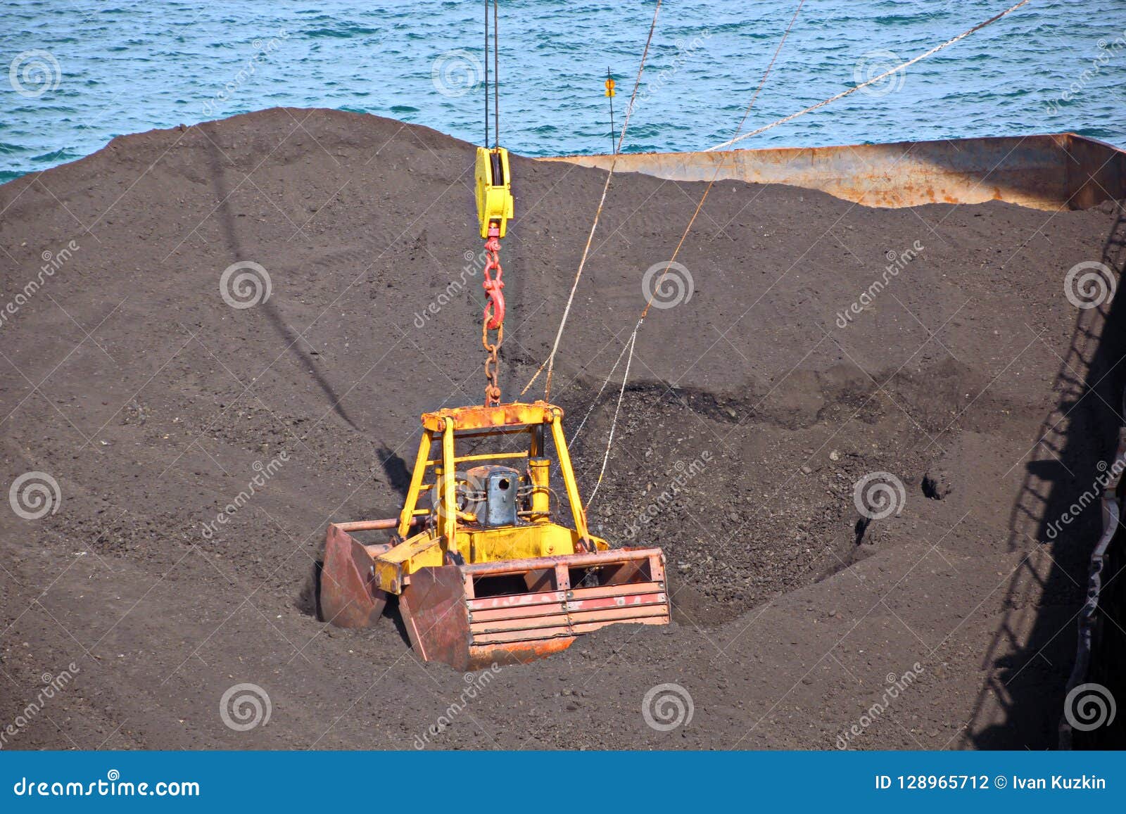 Loading Coal from Cargo Barges Onto a Bulk Carrier Using Ship Cranes ...