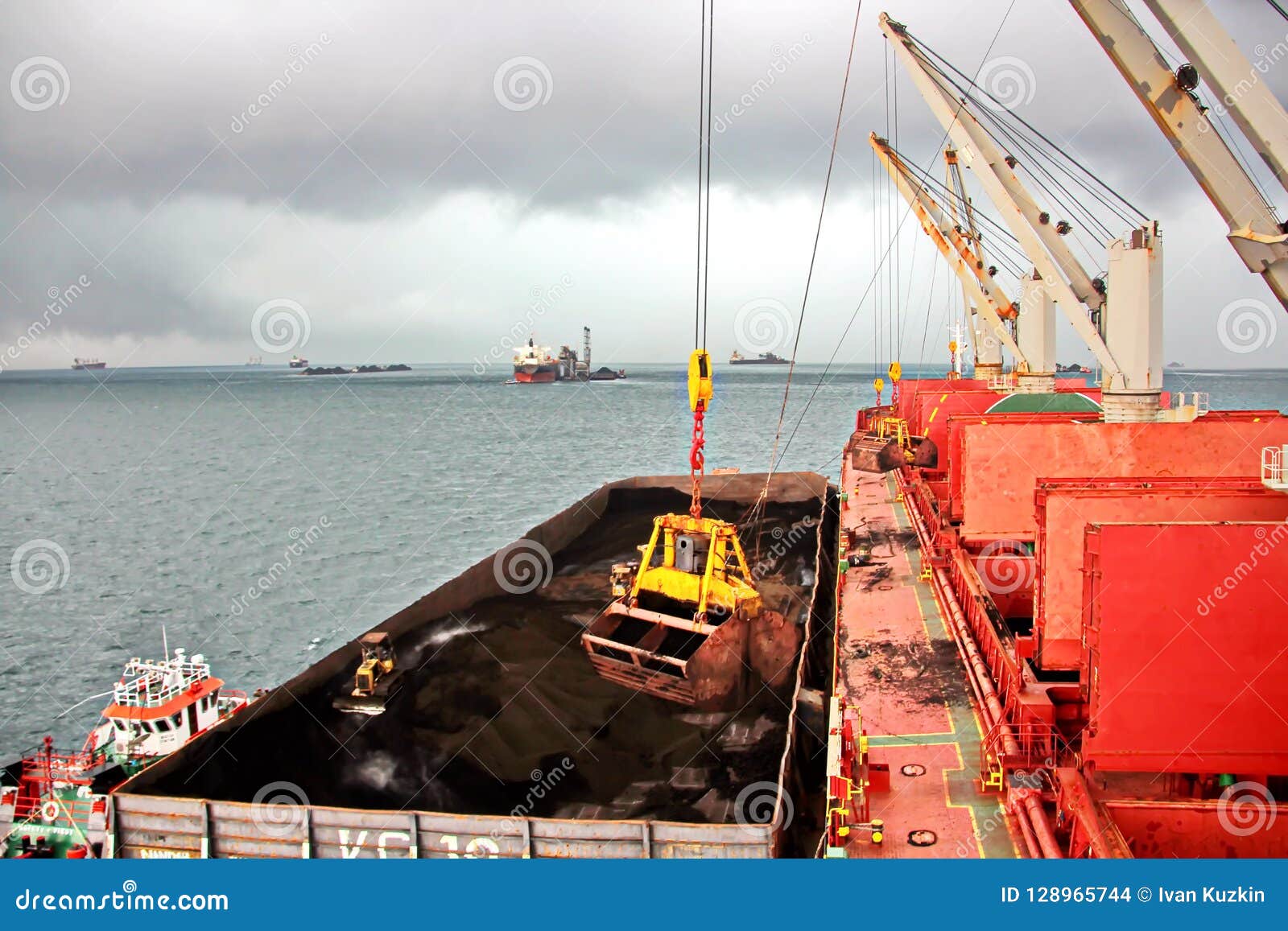 Loading Coal from Cargo Barges Onto a Bulk Carrier Using Ship Cranes ...