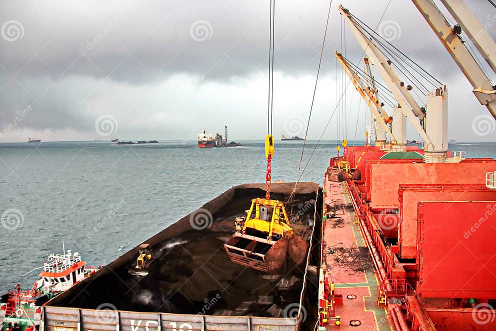 Loading Coal from Cargo Barges Onto a Bulk Carrier Using Ship Cranes ...