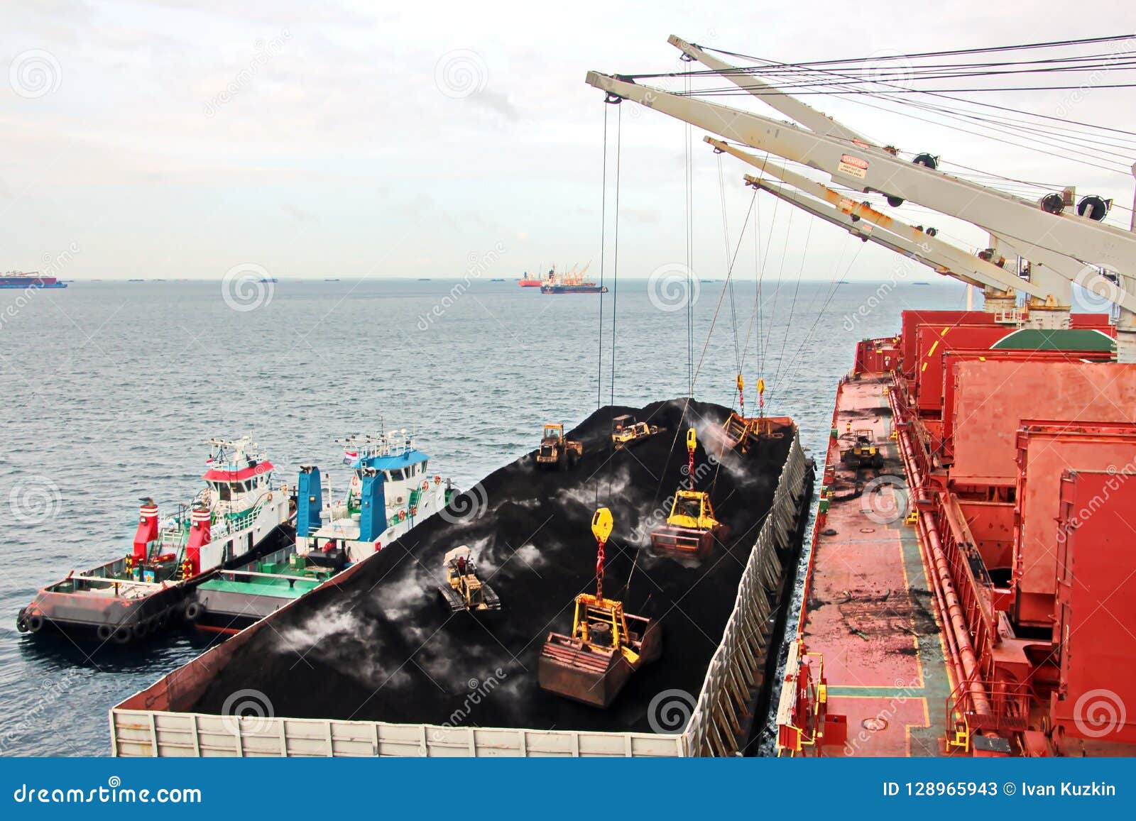 Loading Coal from Cargo Barges Onto a Bulk Carrier Using Ship Cranes ...