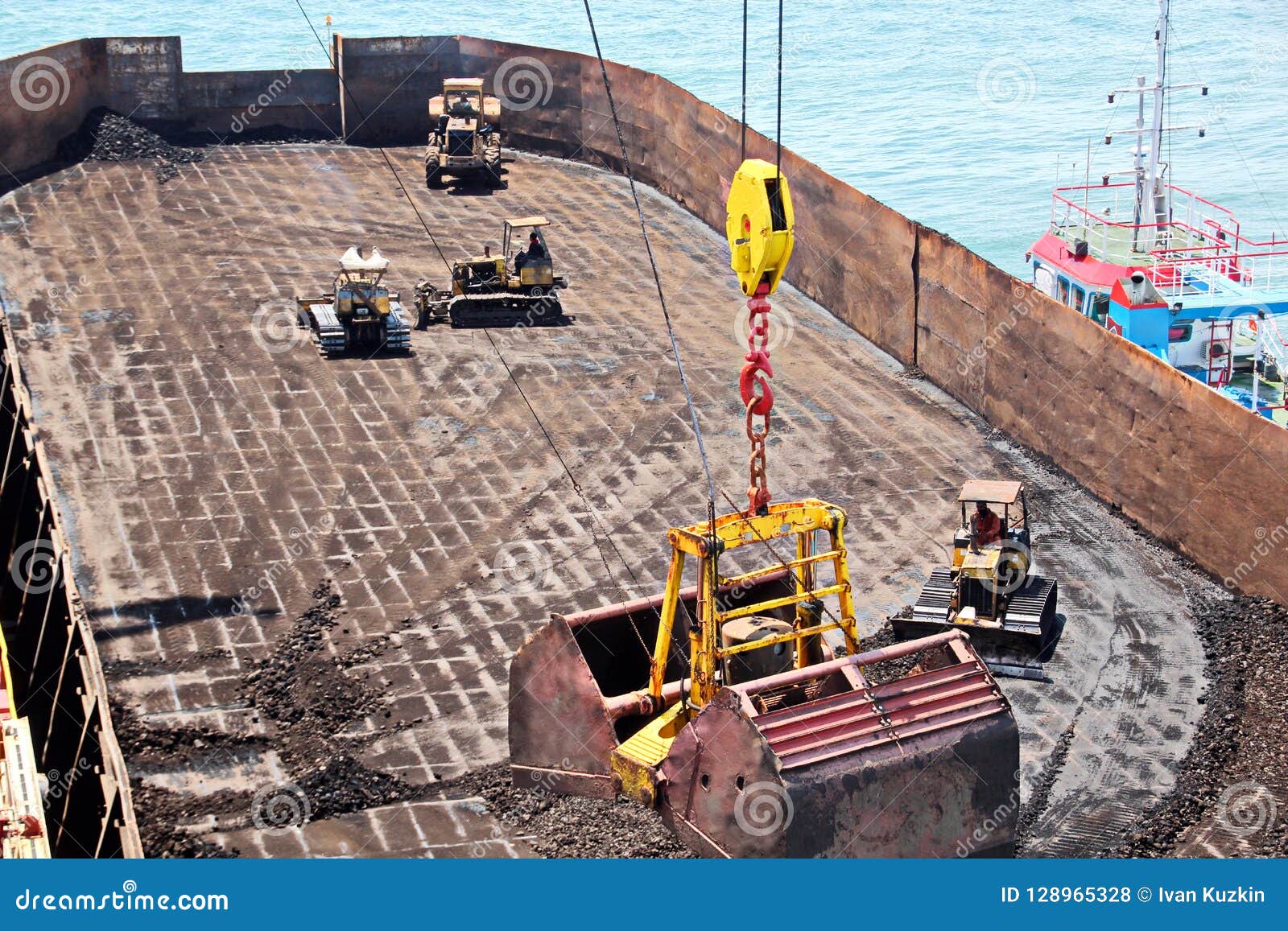 Loading Coal from Cargo Barges Onto a Bulk Carrier Using Ship Cranes ...