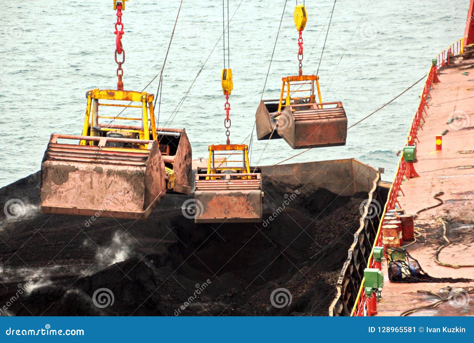Loading Coal from Cargo Barges Onto a Bulk Carrier Using Ship Cranes ...