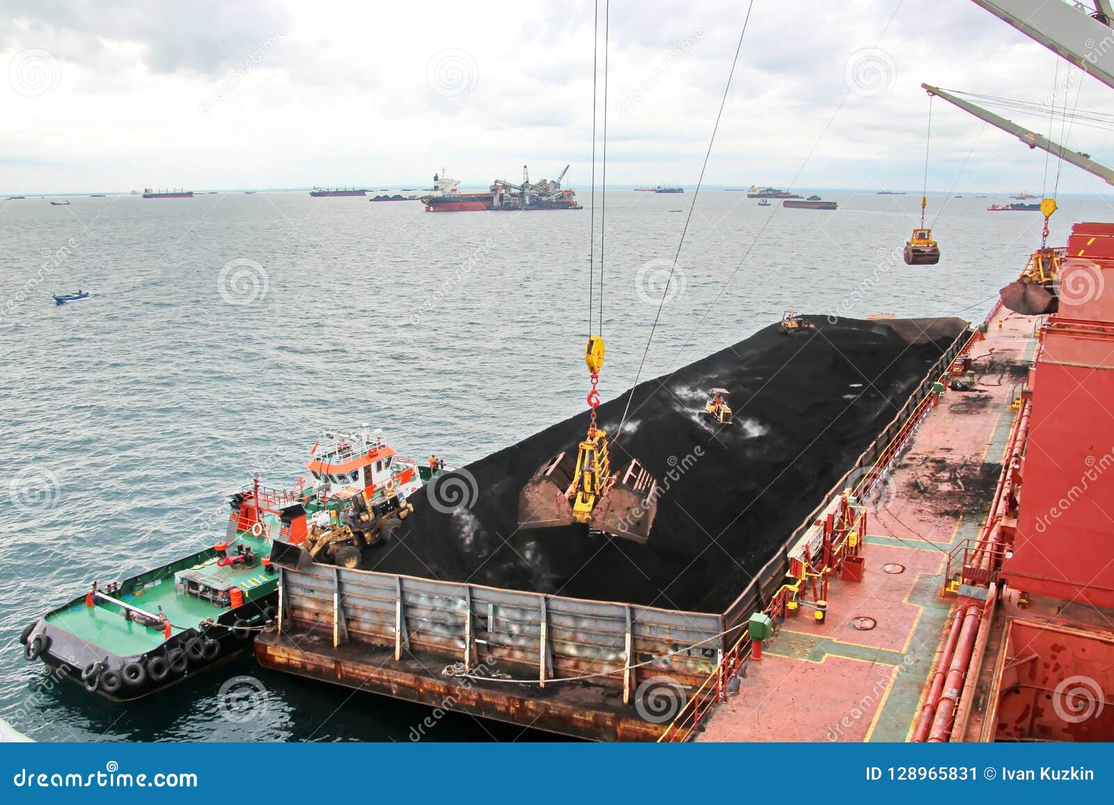 Loading Coal from Cargo Barges Onto a Bulk Carrier Using Ship Cranes ...