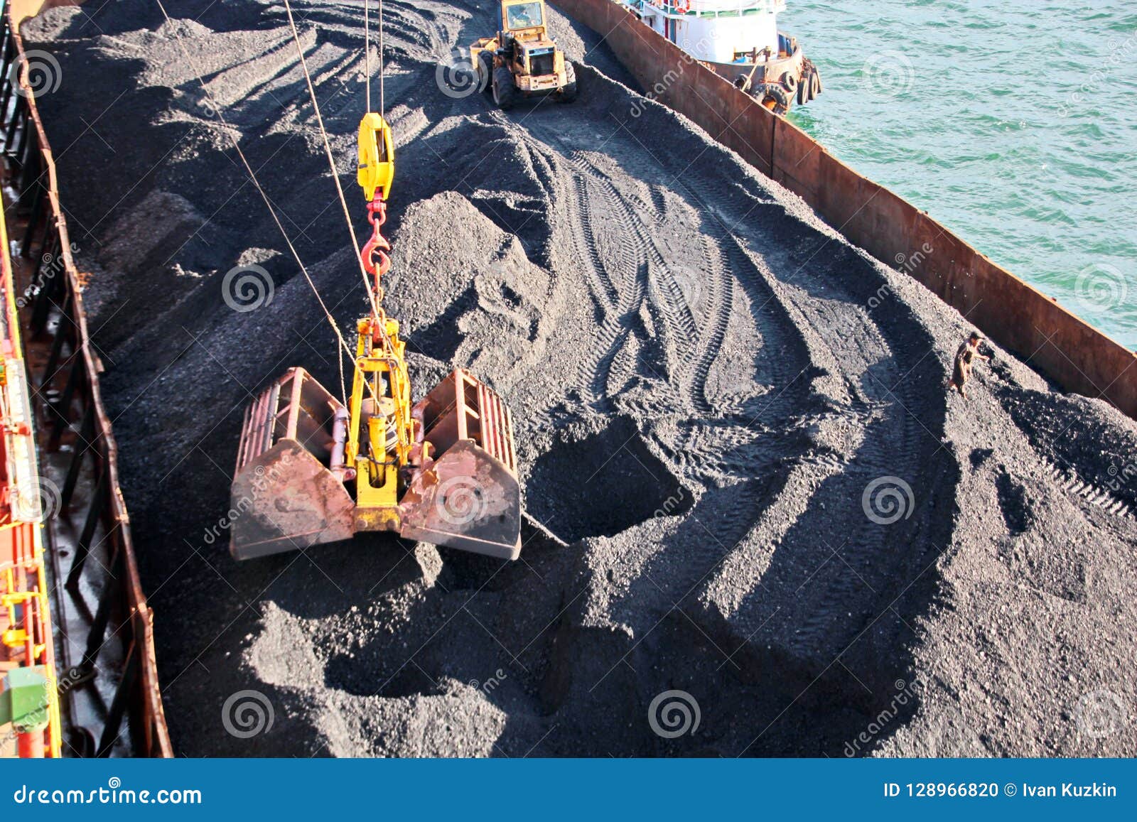 Loading Coal from Cargo Barges Onto a Bulk Carrier Using Ship Cranes ...