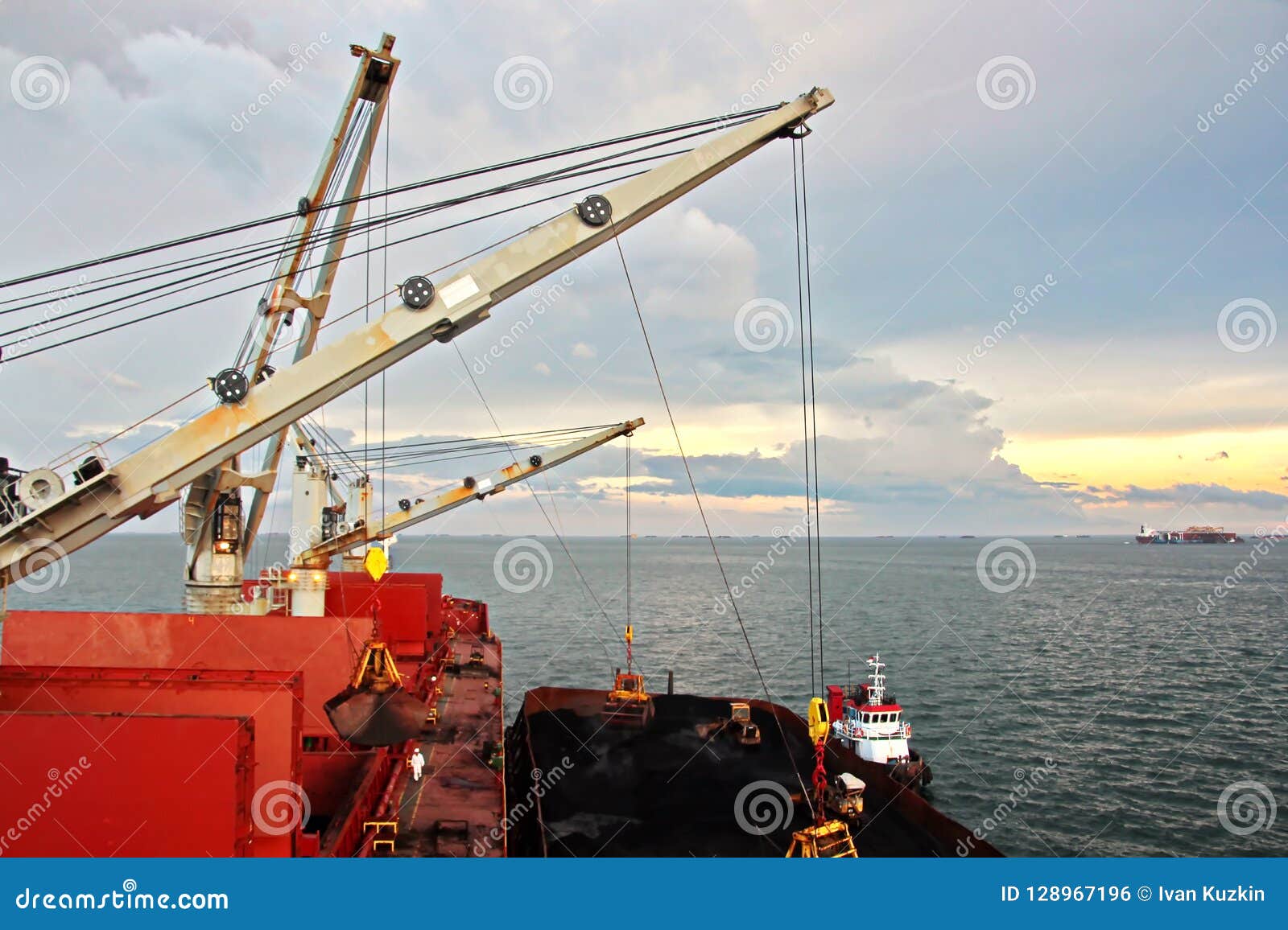 Loading Coal from Cargo Barges Onto a Bulk Carrier Using Ship Cranes ...