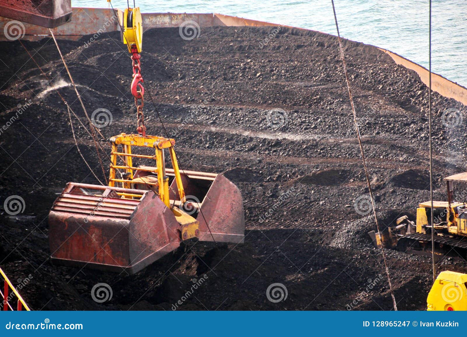 Loading Coal from Cargo Barges Onto a Bulk Carrier Using Ship Cranes ...