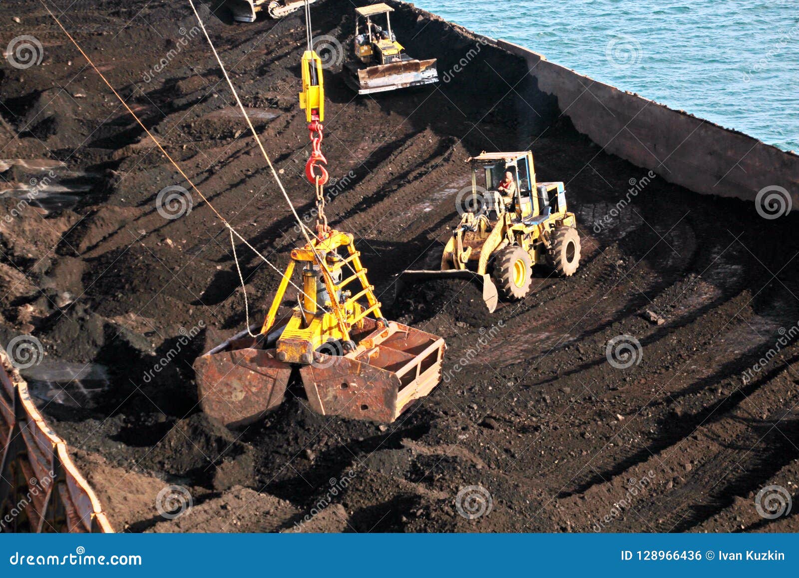 Loading Coal from Cargo Barges Onto a Bulk Carrier Using Ship Cranes ...