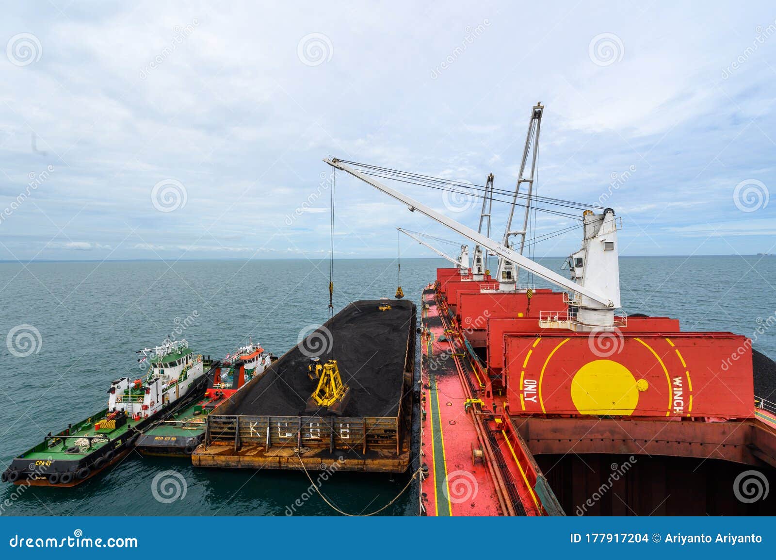 Loading Coal from Cargo Barges Onto a Bulk Vessel Using Ship Cranes ...