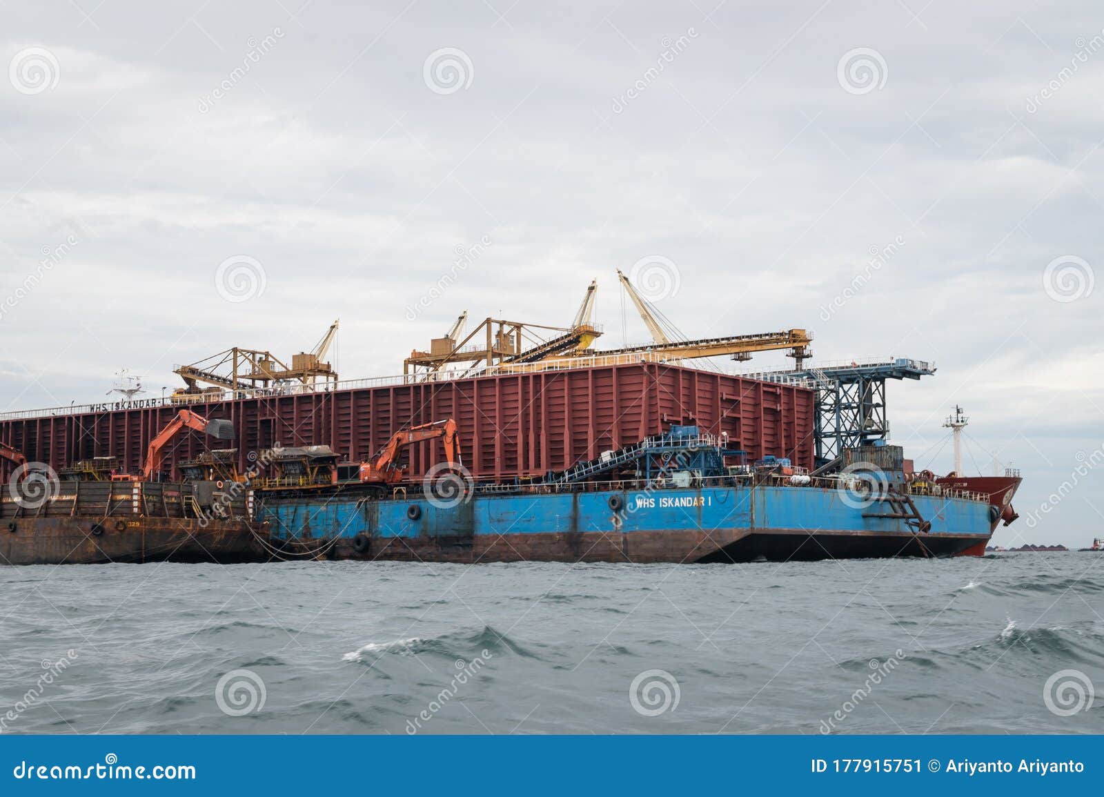 Loading Coal from Cargo Barges Onto a Bulk Vessel Using Ship Cranes ...