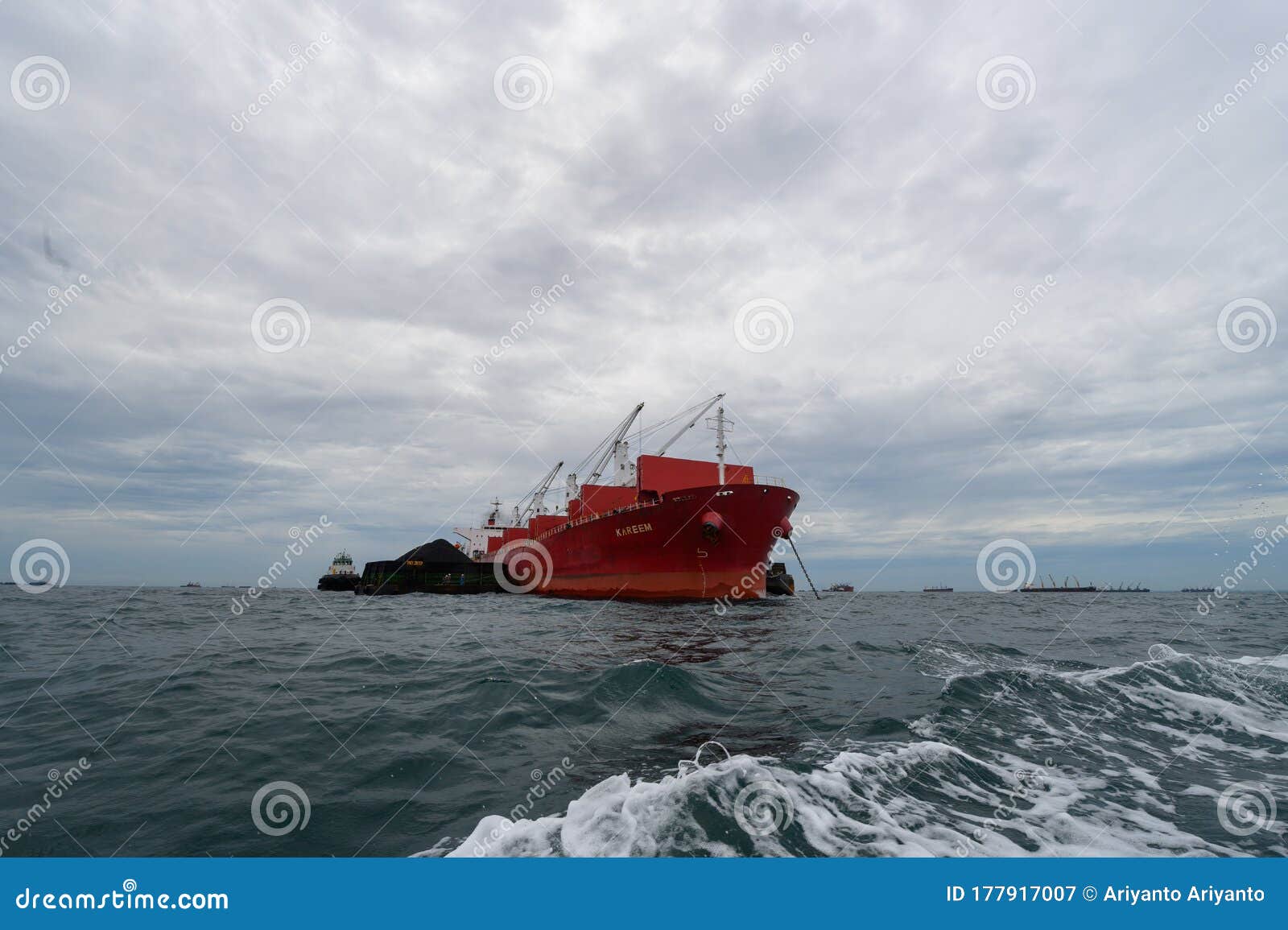 Loading Coal from Cargo Barges Onto a Bulk Vessel Using Ship Cranes ...