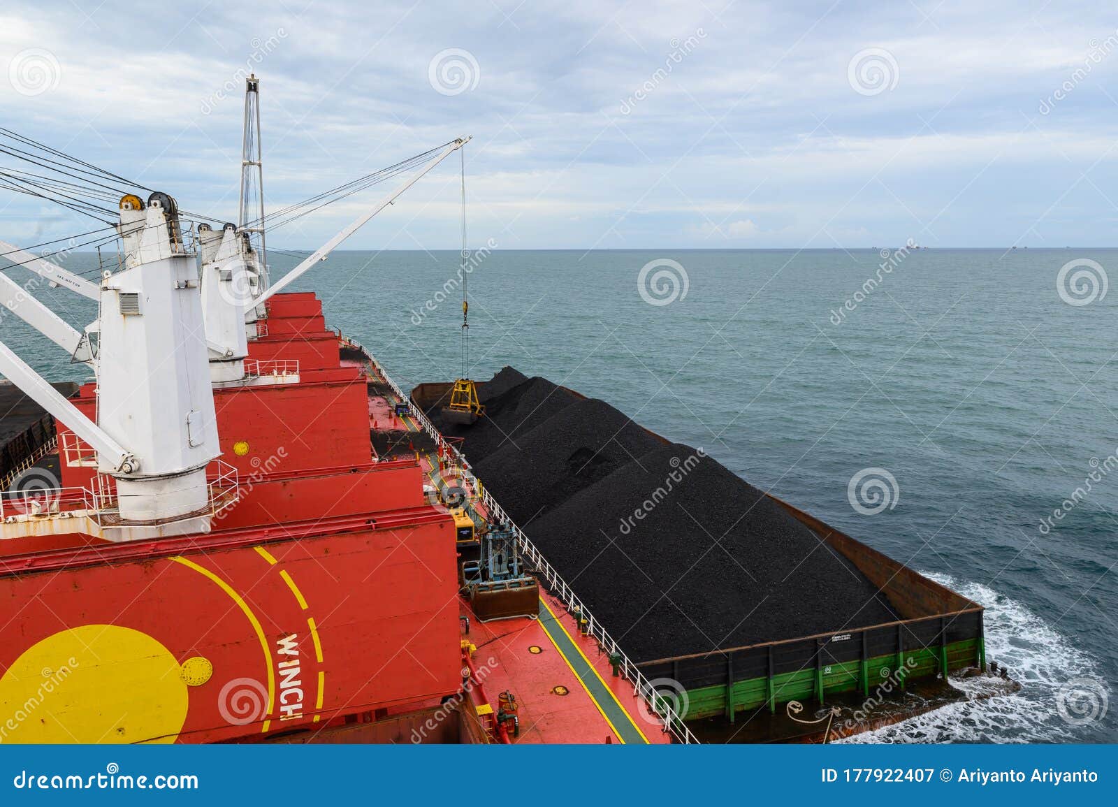 Loading Coal from Cargo Barges Onto a Bulk Vessel Using Ship Cranes ...