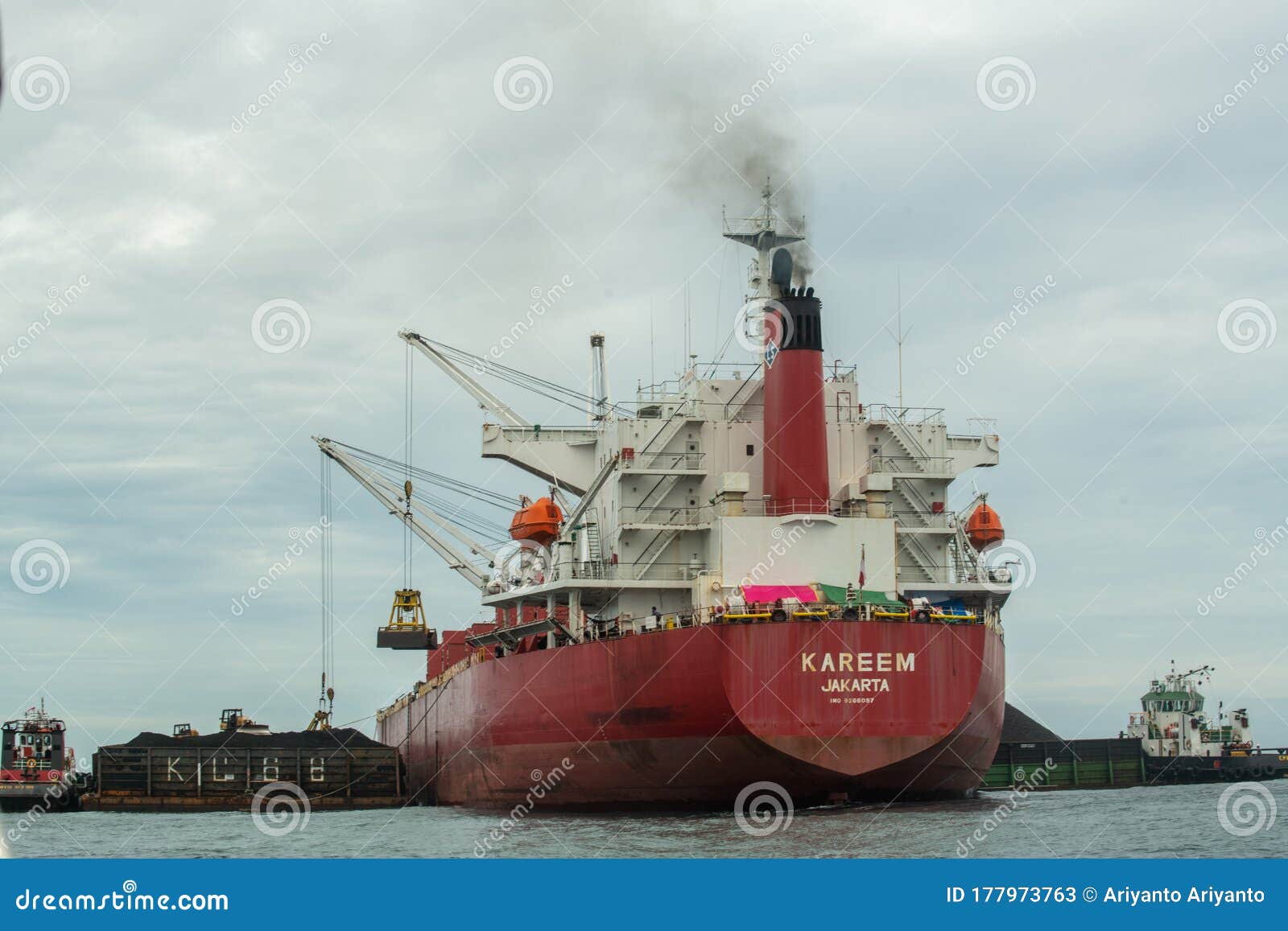 Loading Coal from Cargo Barges Onto a Bulk Vessel Using Ship Cranes ...