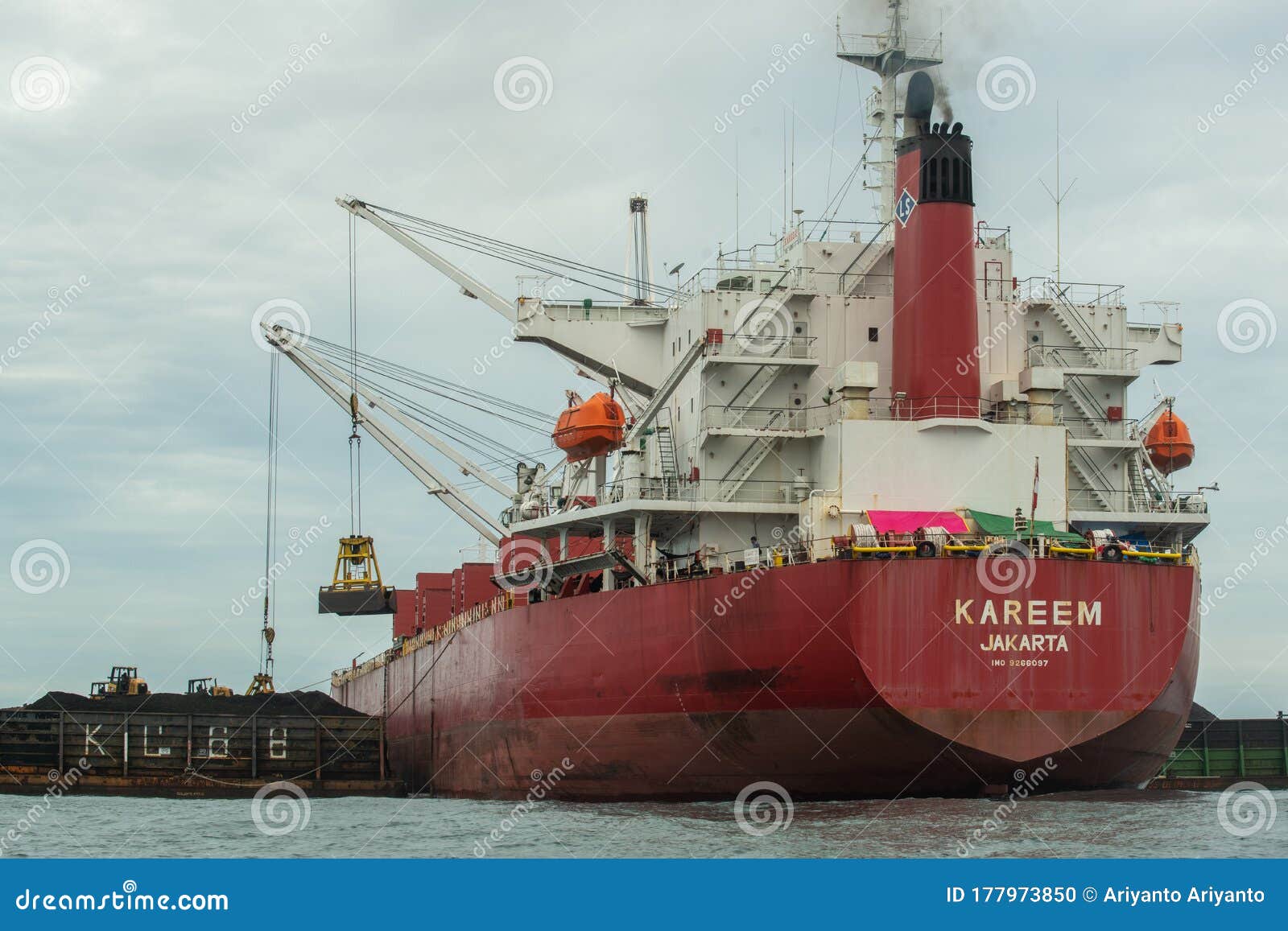 Loading Coal from Cargo Barges Onto a Bulk Vessel Using Ship Cranes ...