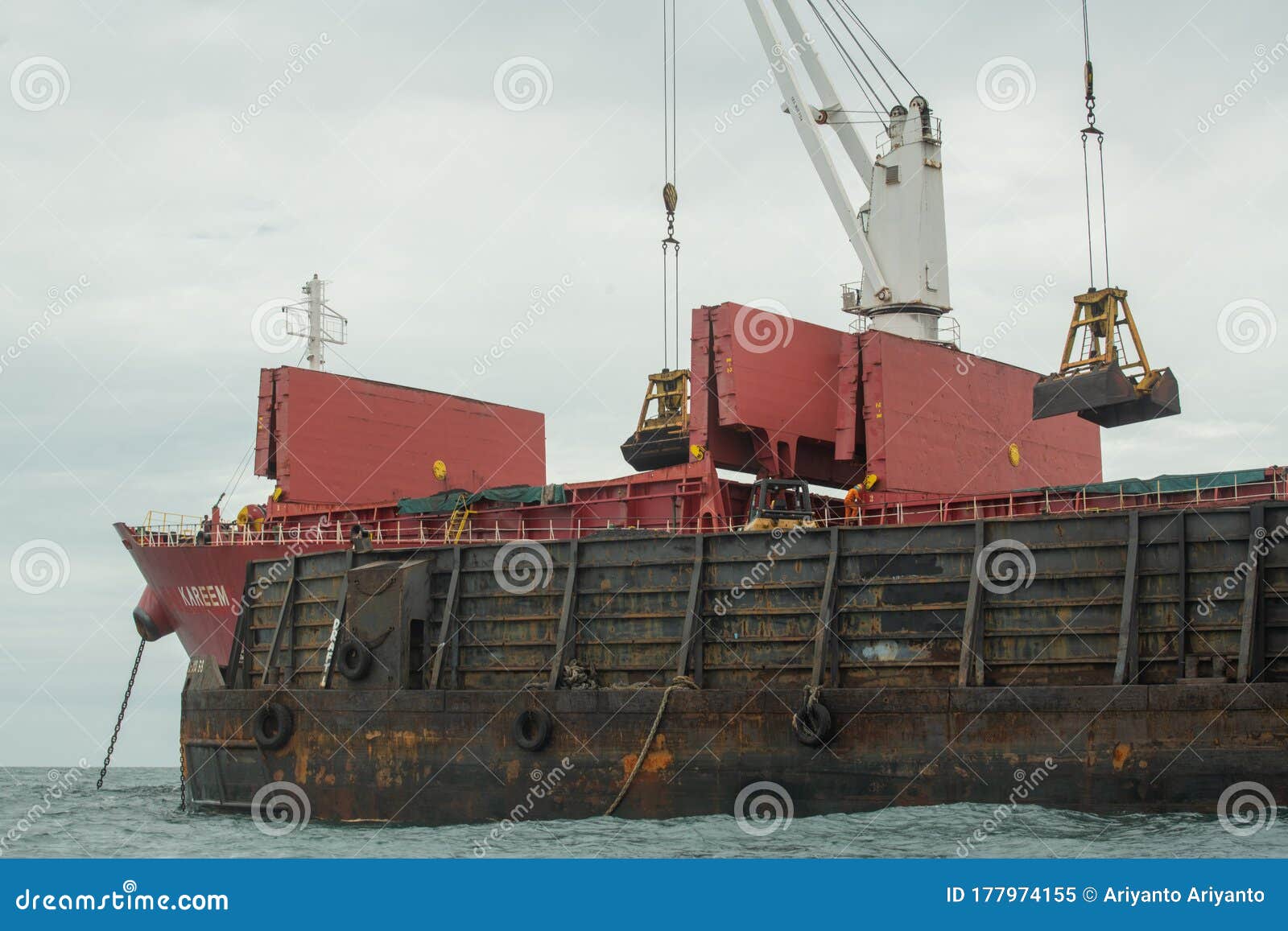 Loading Coal from Cargo Barges Onto a Bulk Vessel Using Ship Cranes ...