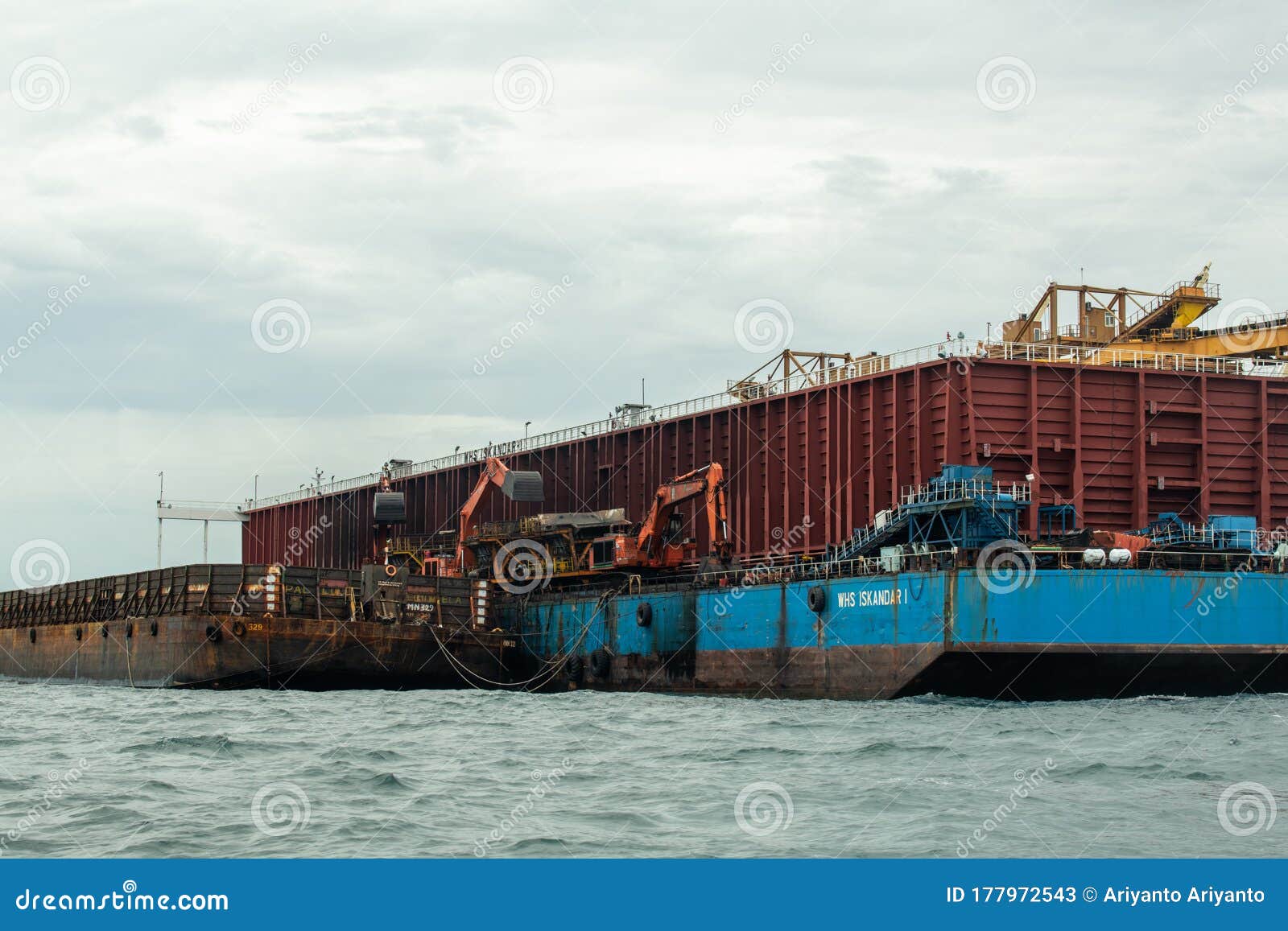 Loading Coal from Cargo Barges Onto a Bulk Vessel Using Ship Cranes ...
